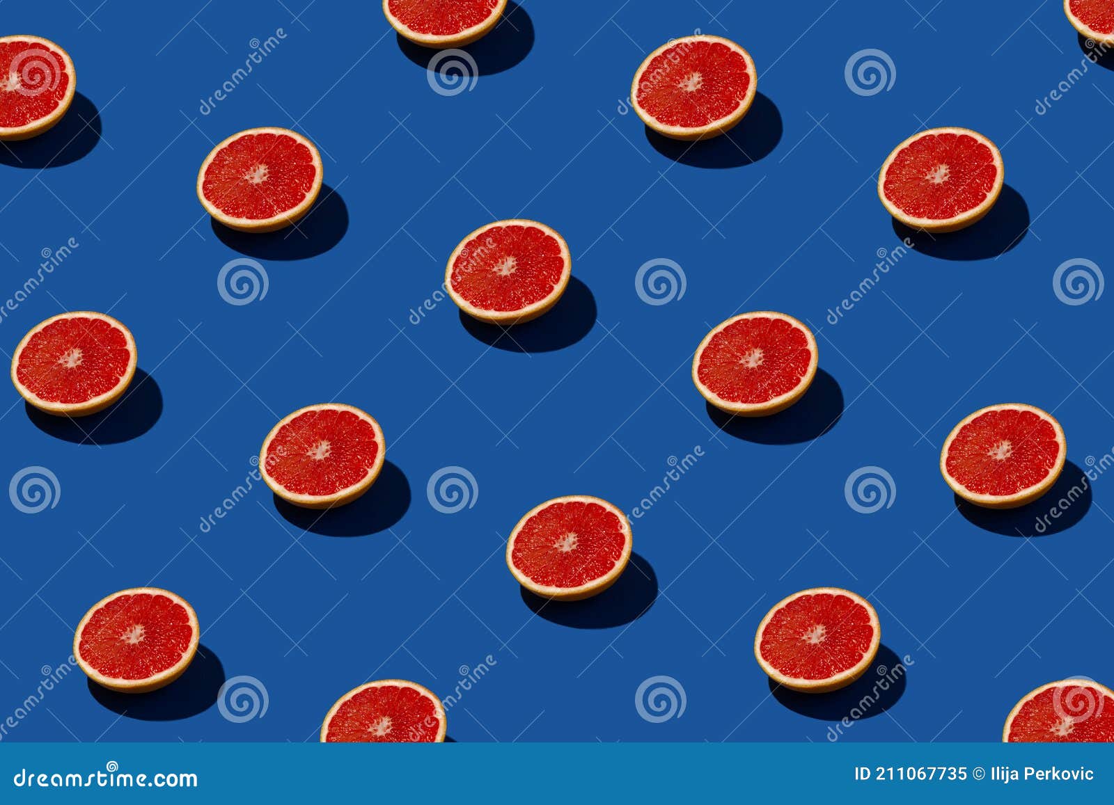 Red Grapefruit Sunlit Pattern on a Deep Blue Background. Minimal ...