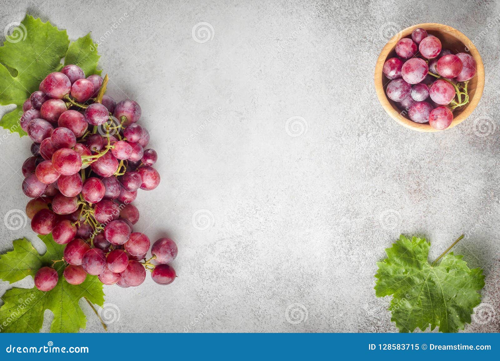 Red Grapes with Leaves of Grapes on a Stone Table. Top View. Free Space ...