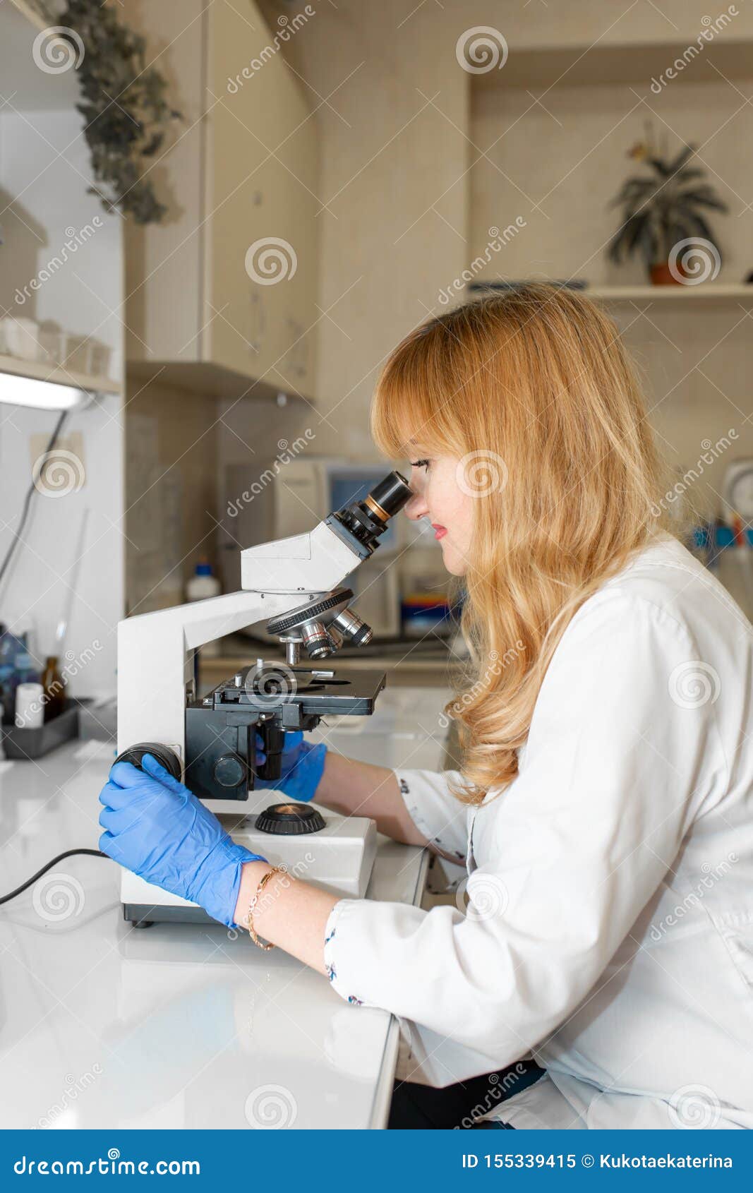 Red Hair Woman Lab Technician Looking through Microscope Analyse Blood ...