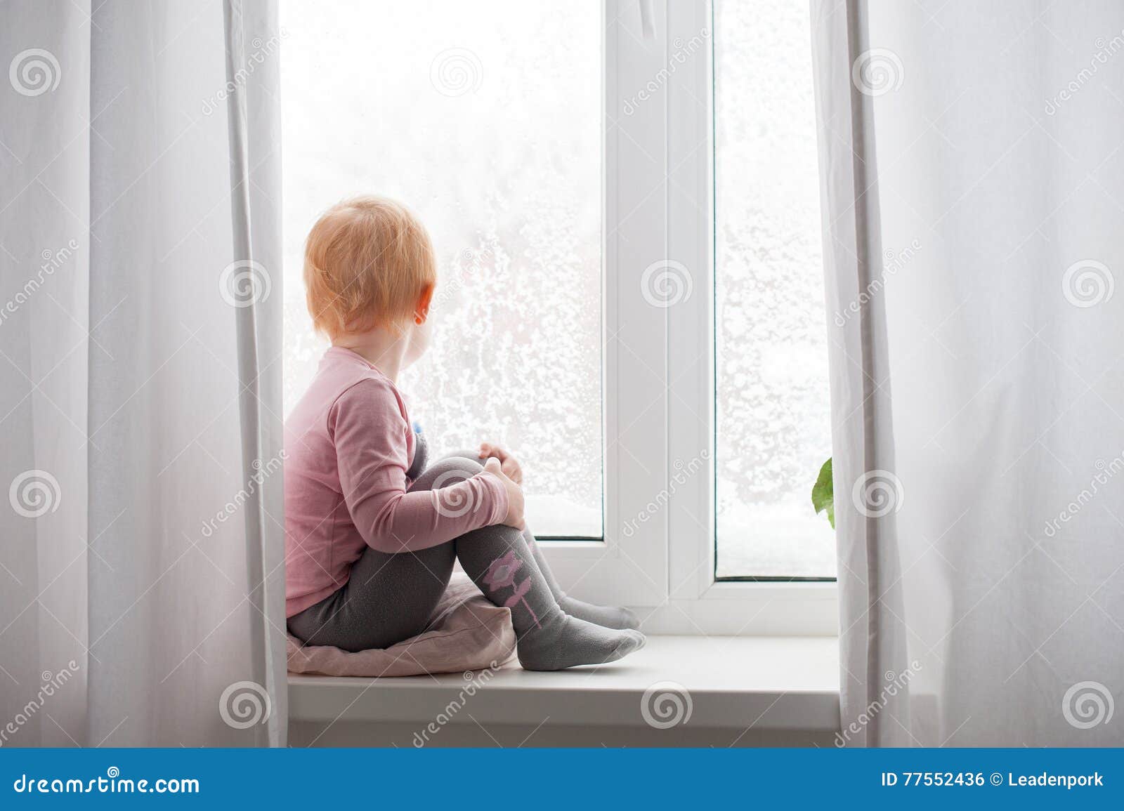 The Red-haired Child is Sitting on Window Stock Photo - Image of snow ...