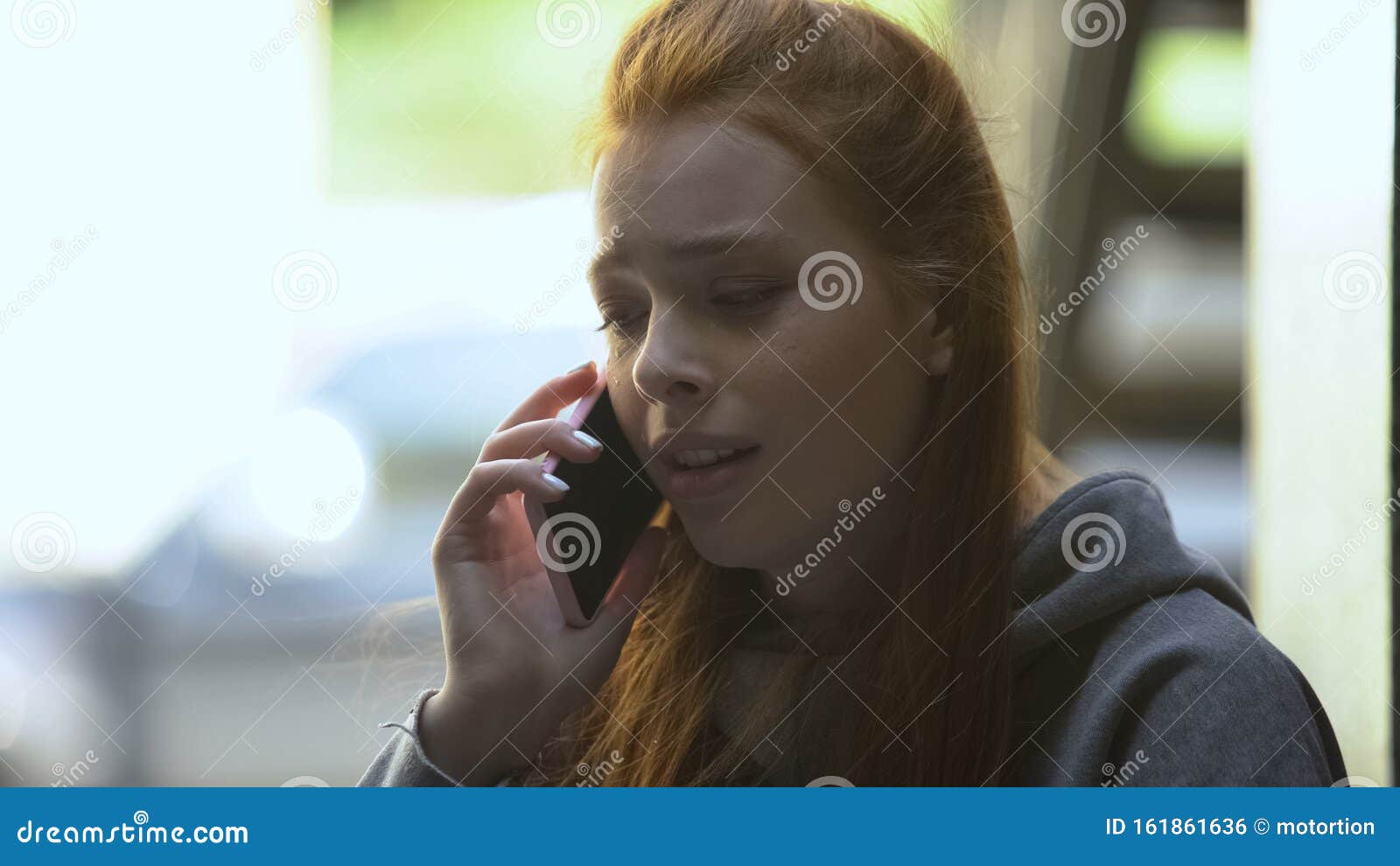 Red-haired Young Female Crying and Talking on Smartphone, Needs Help ...