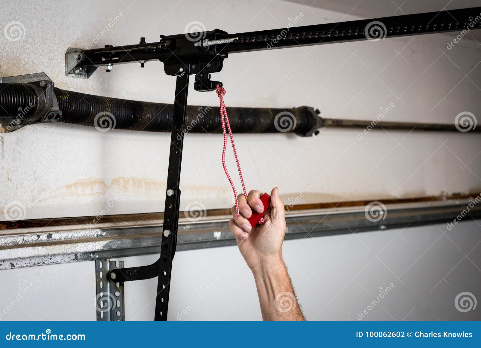 Man Pulls Red Quick Release for a Garage Door Opener Stock Photo ... Man Pulls Red Quick Release for a Garage Door Opener Stock Photo ...