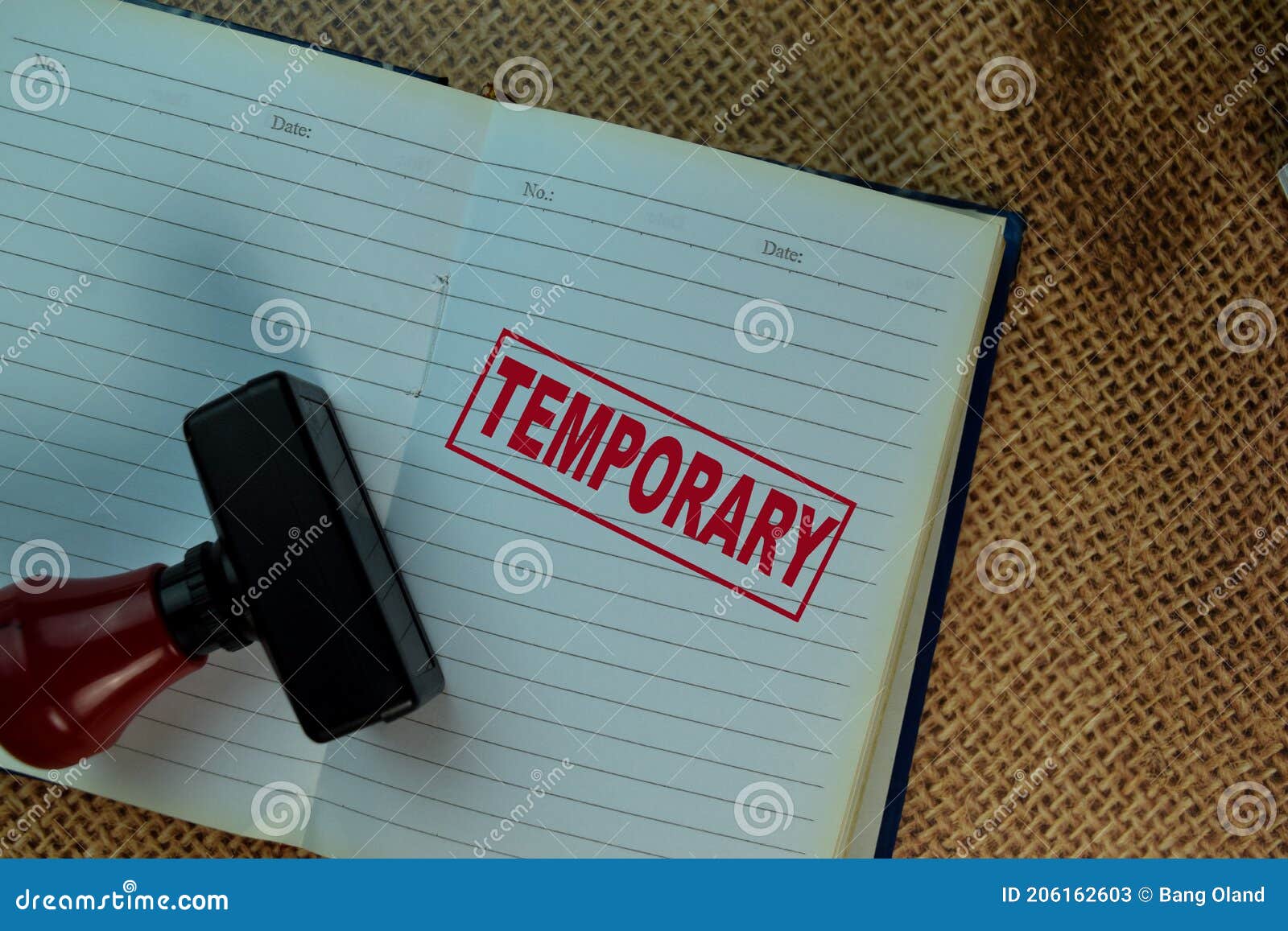 Red Handle Rubber Stamper and Temporary Text Isolated on Brown Burlap ...