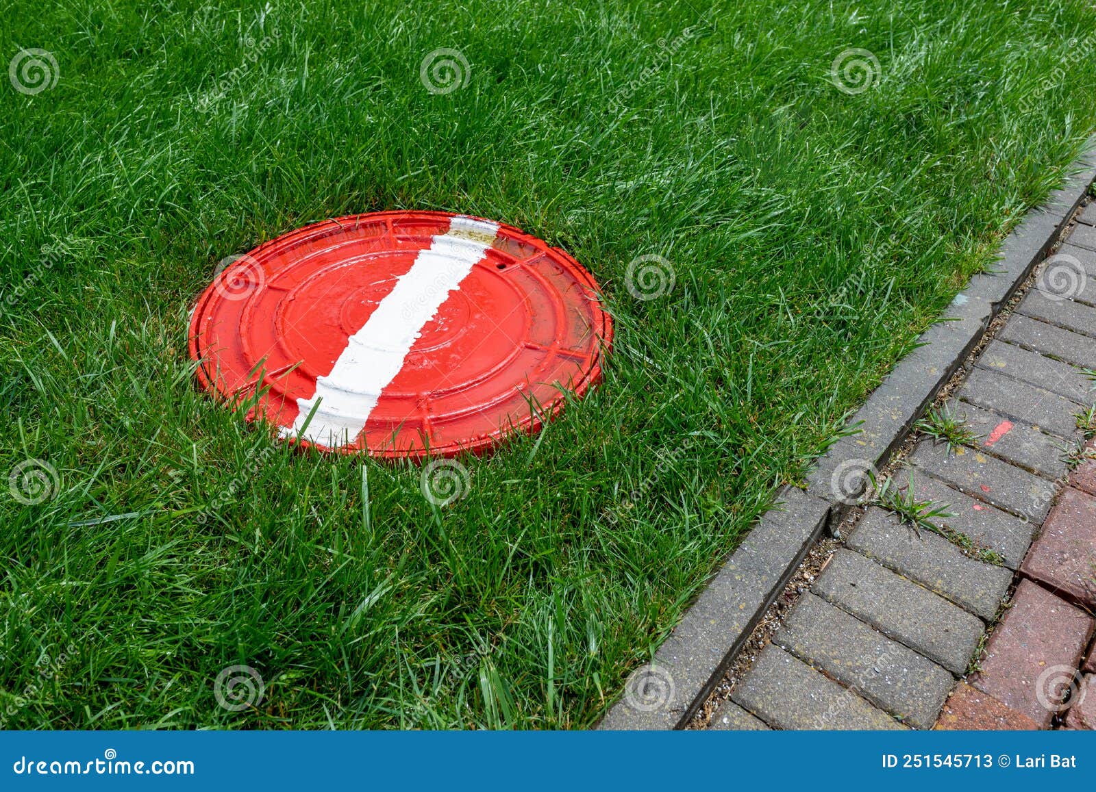 Red Hatch with White Stripe on Green Lawn. Sewer Cover or Fire Hydrant ...