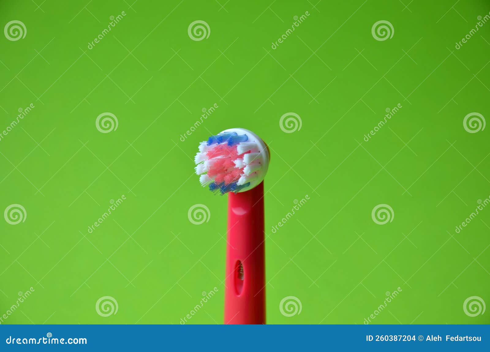 Red Head for an Electric Toothbrush. Green Background. Stock Photo ...