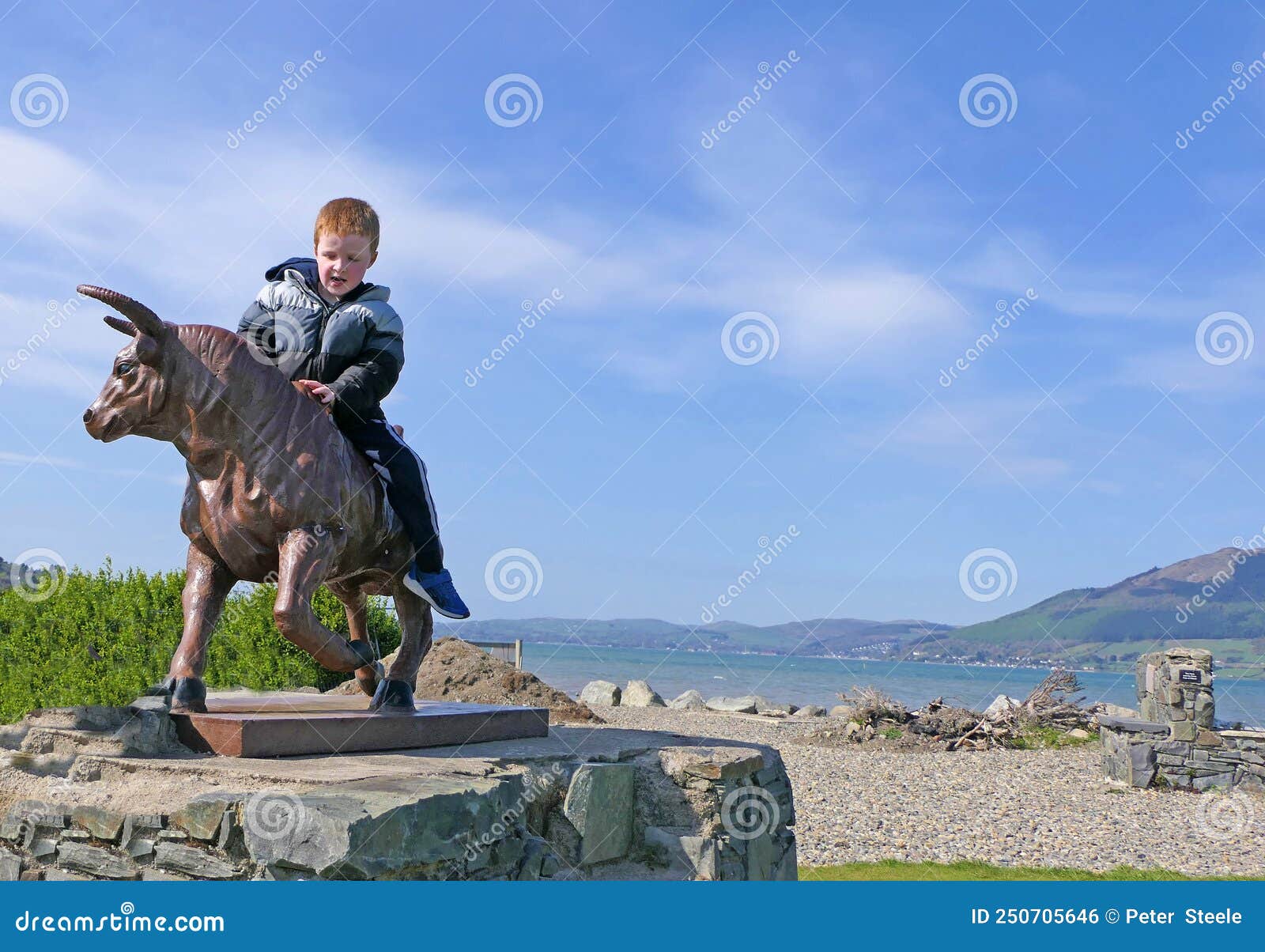 Red Headed Boy Riding a Statue Bull Ireland Stock Photo - Image of fish ...
