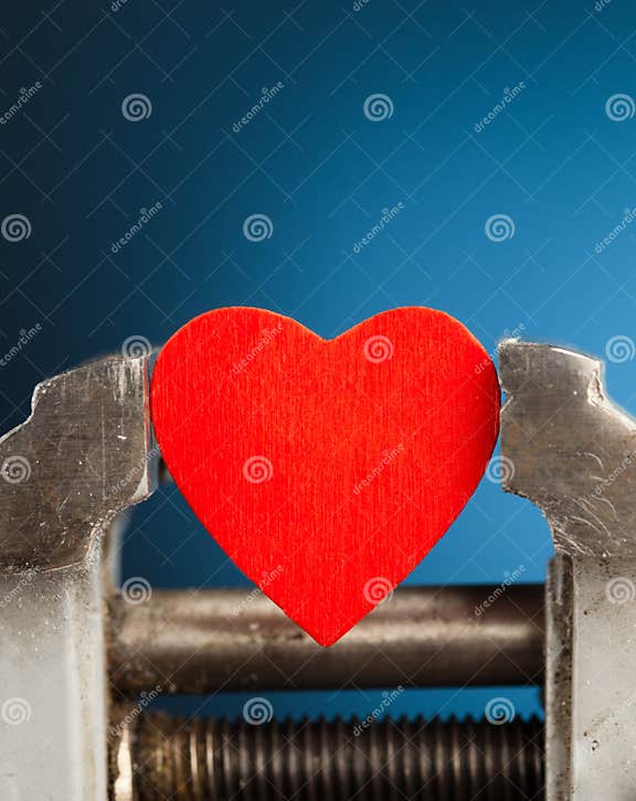 Red heart in the vice tool stock photo. Image of metallic - 33908806