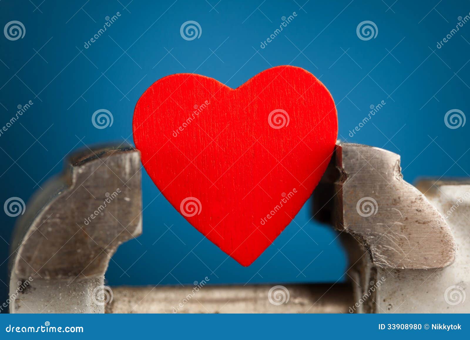 Red heart in the vice tool stock photo. Image of instrument - 33908980