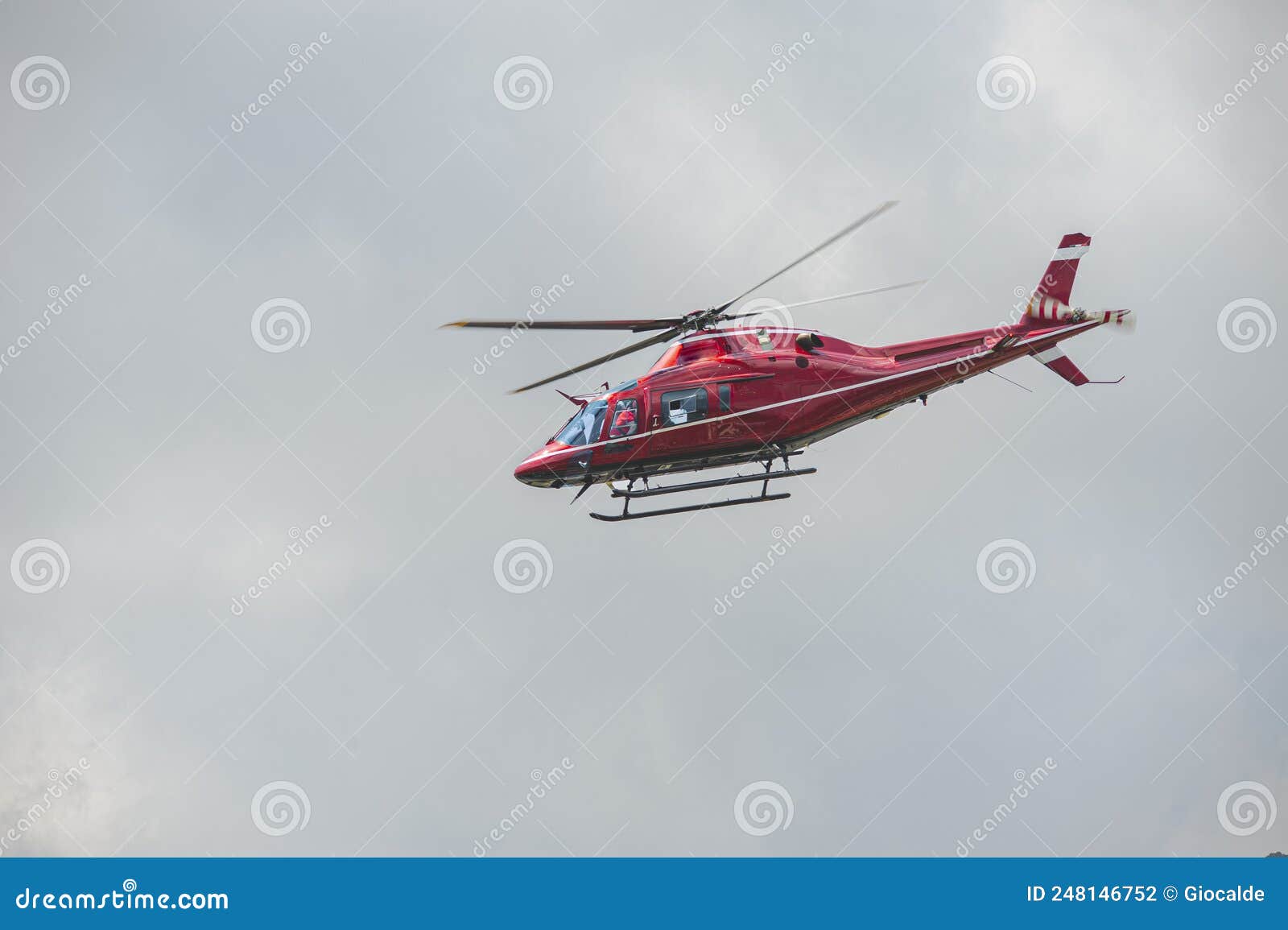 Red helicopter in flight stock photo. Image of fast - 248146752