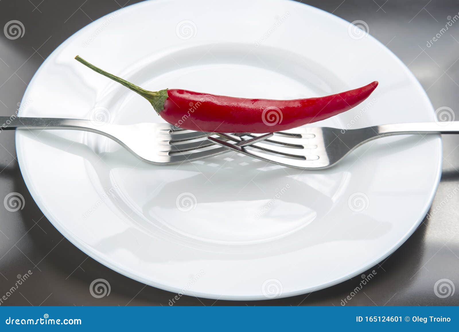 Red Hot Pepper on a Fork on a Ceramic Plate. Spices and Vegetative Food ...