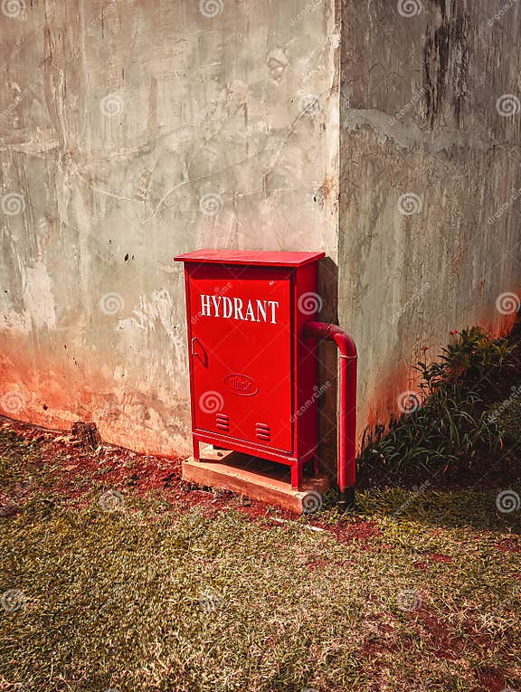 Red Hydrant Box Attached To the Wall of the House Stock Photo - Image ...