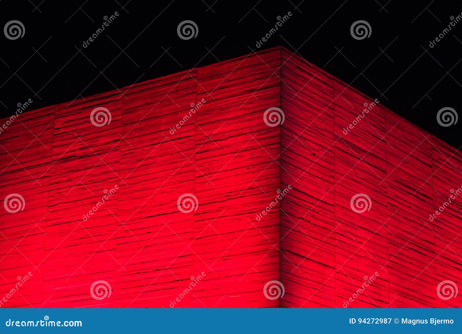 Red Illuminated Concrete Wall of Brutalist Building at Night Stock ...