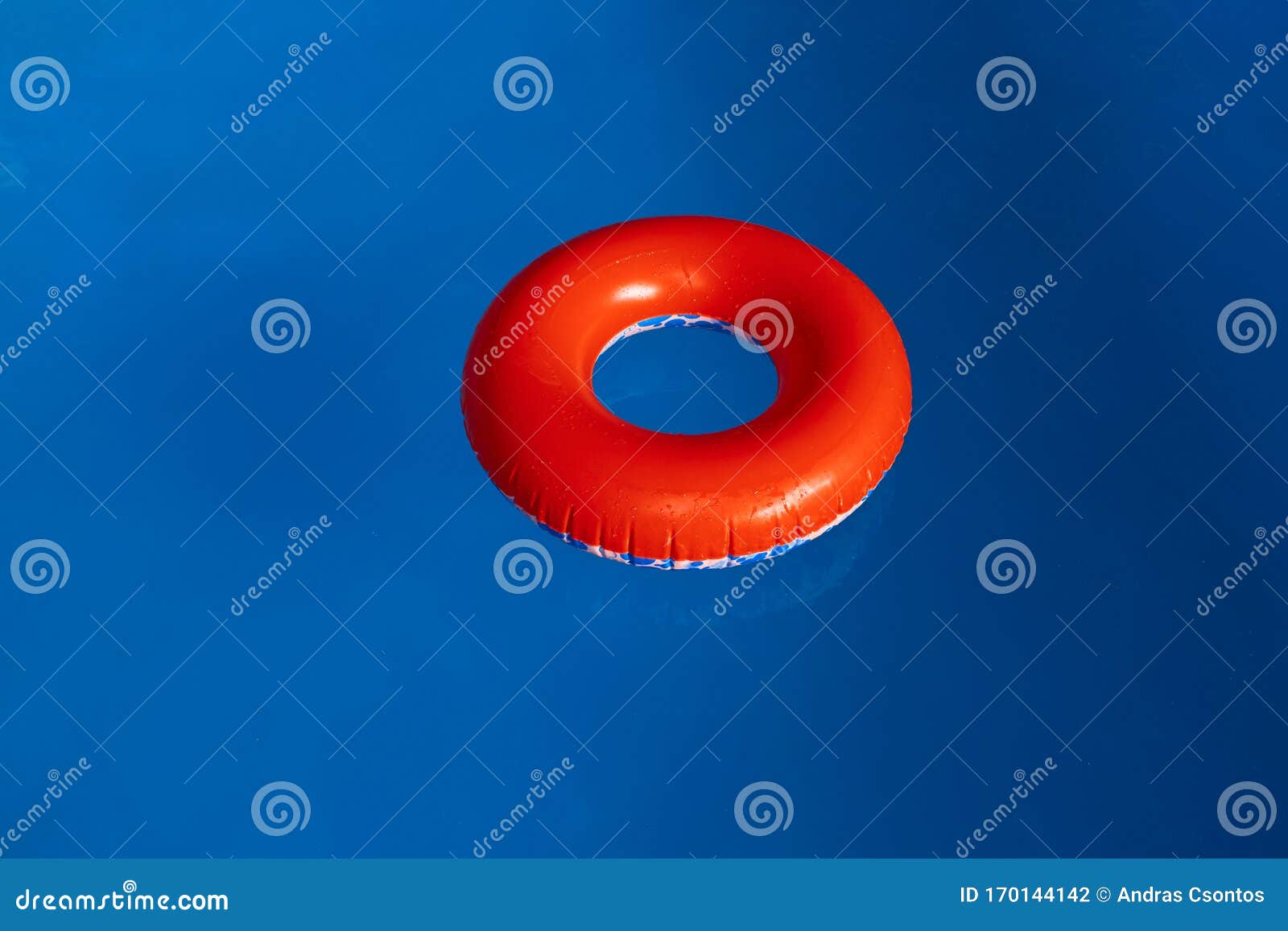 Red Inflatable Swim Ring on a Swimming Pool Stock Photo - Image of ...
