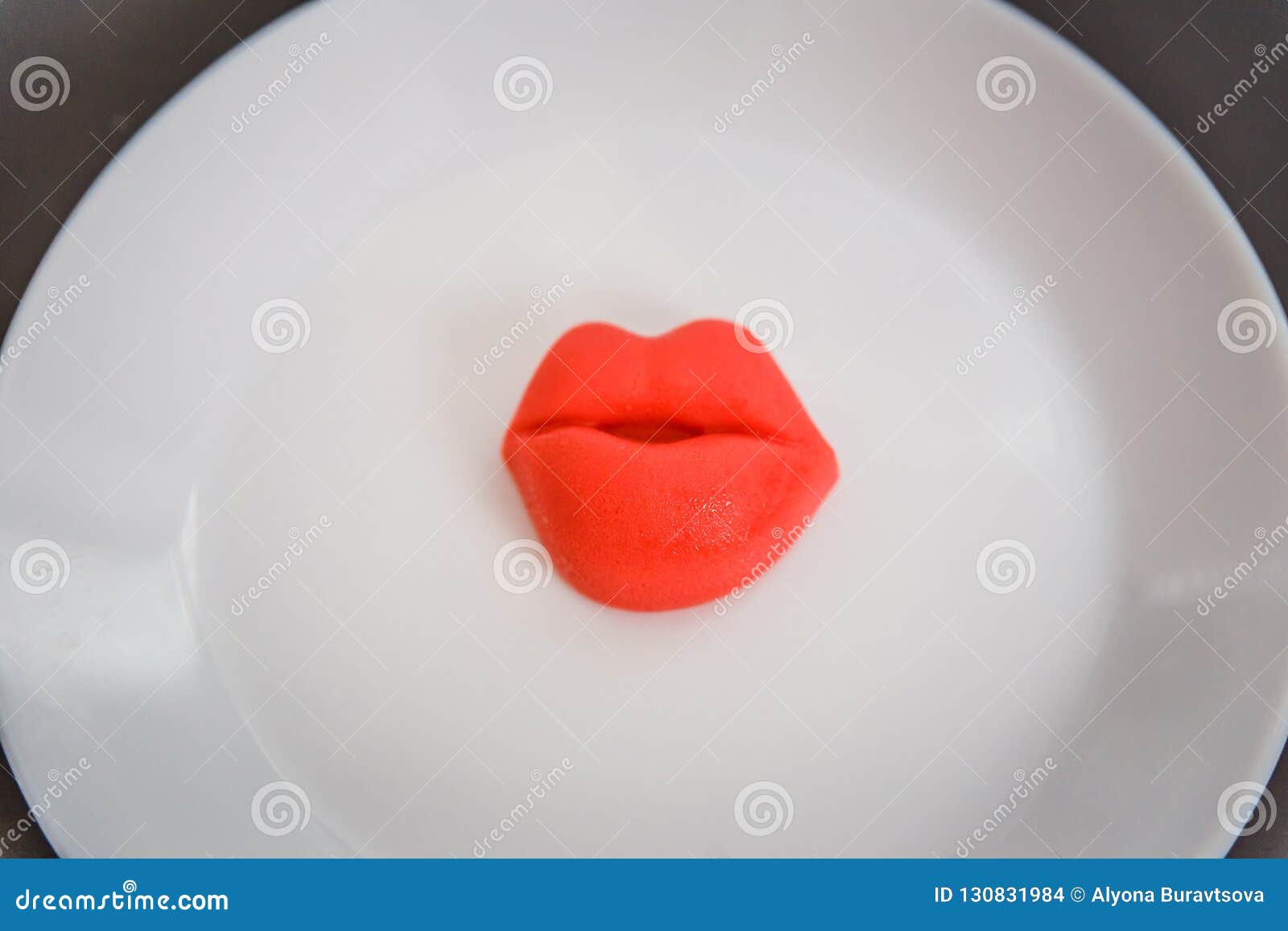 Red lips on a white plate stock photo. Image of lips - 130831984