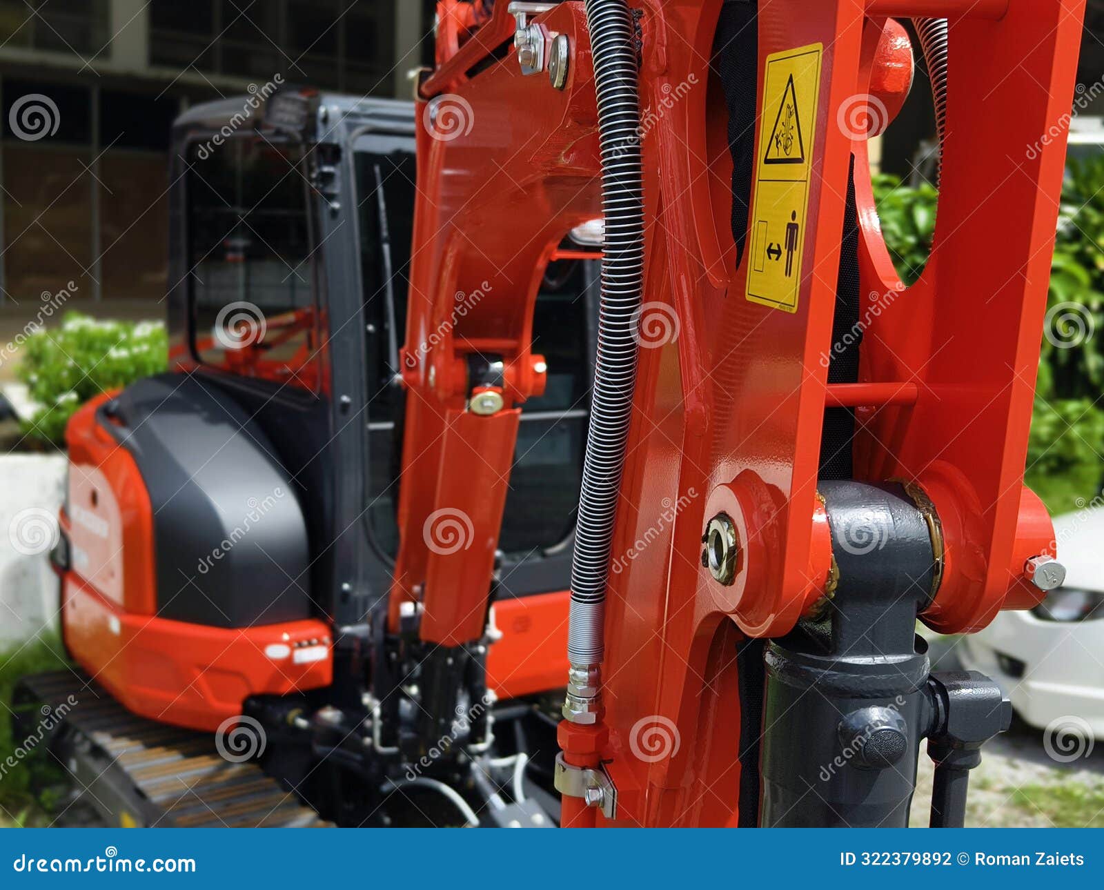 Red Large Excavators are Stationed in a Green Field in Front of a ...