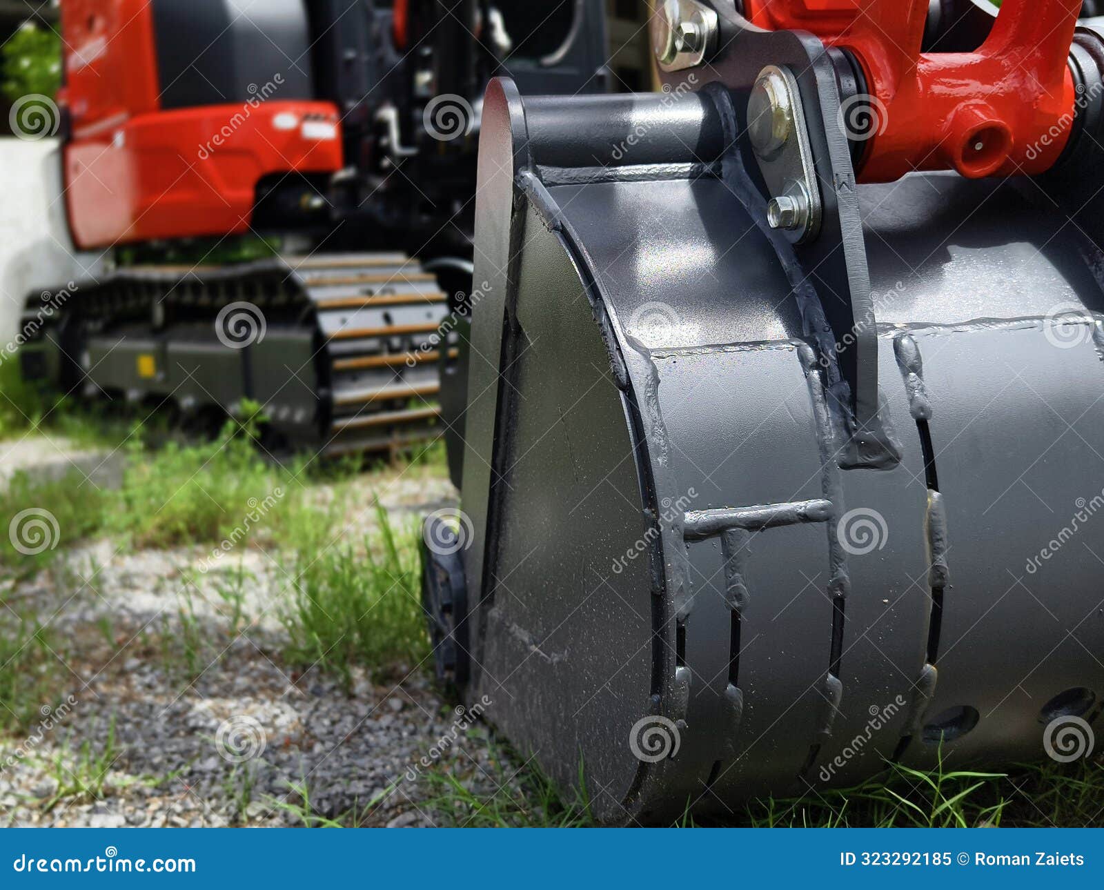 Red Large Excavators are Stationed in a Green Field in Front of a ...
