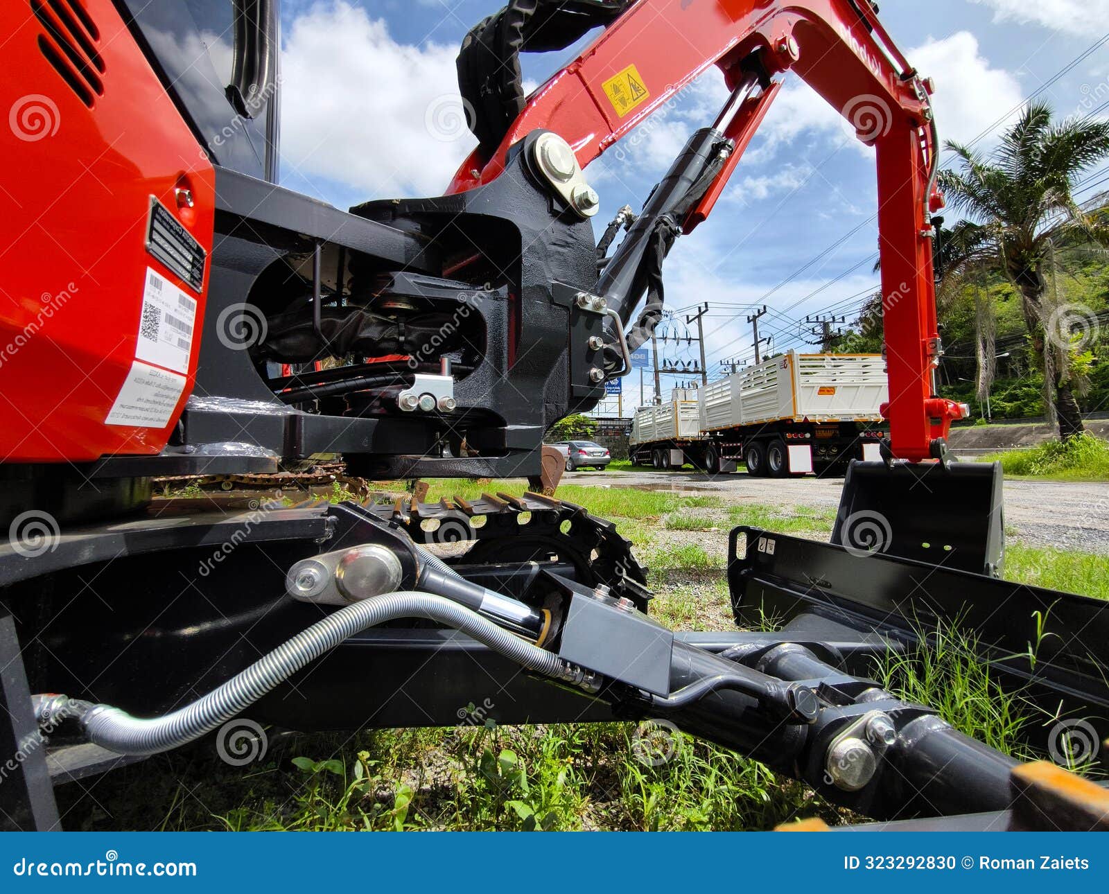 Red Large Excavators are Stationed in a Green Field in Front of a ...