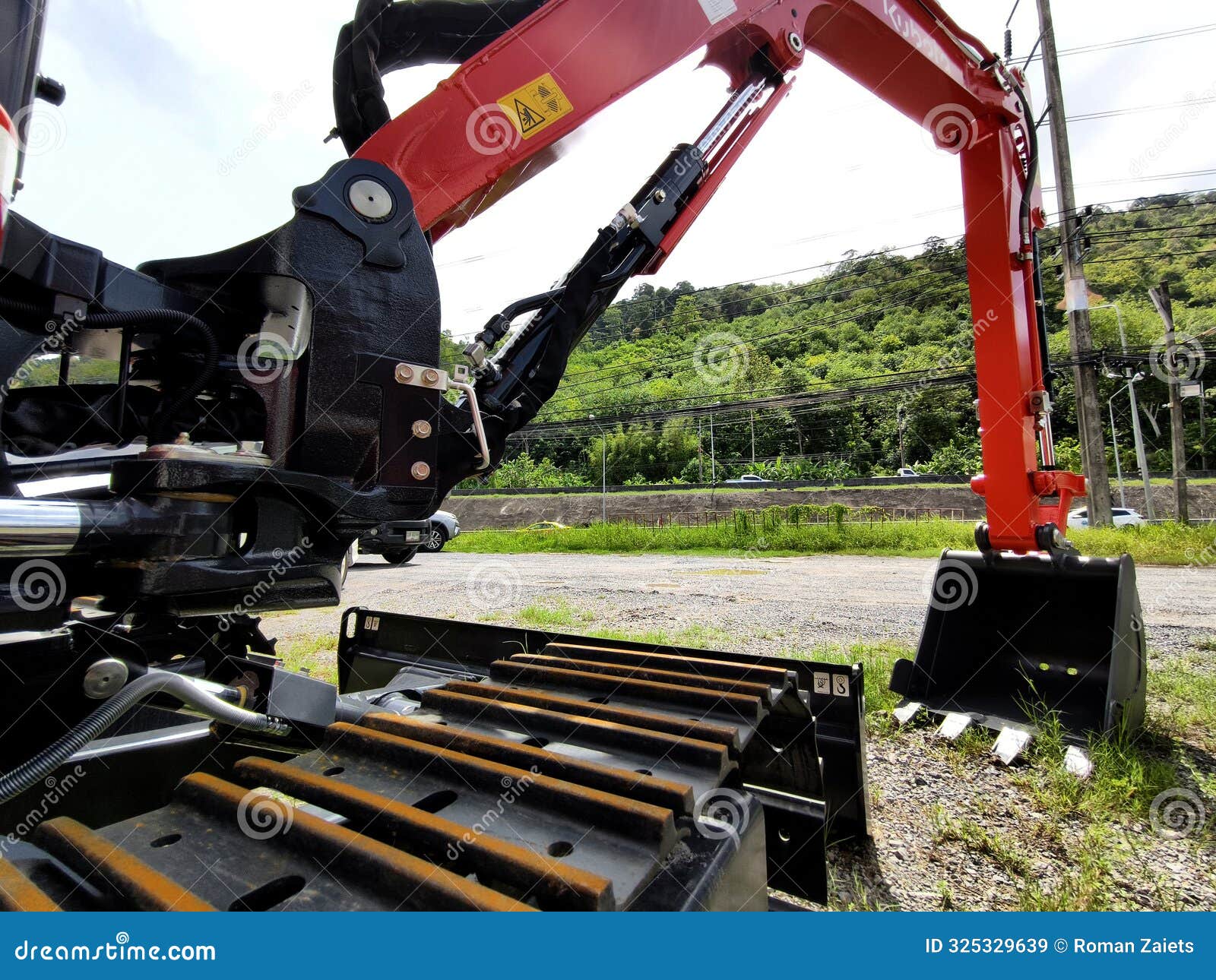 Red Large Excavators are Stationed in a Green Field in Front of a ...
