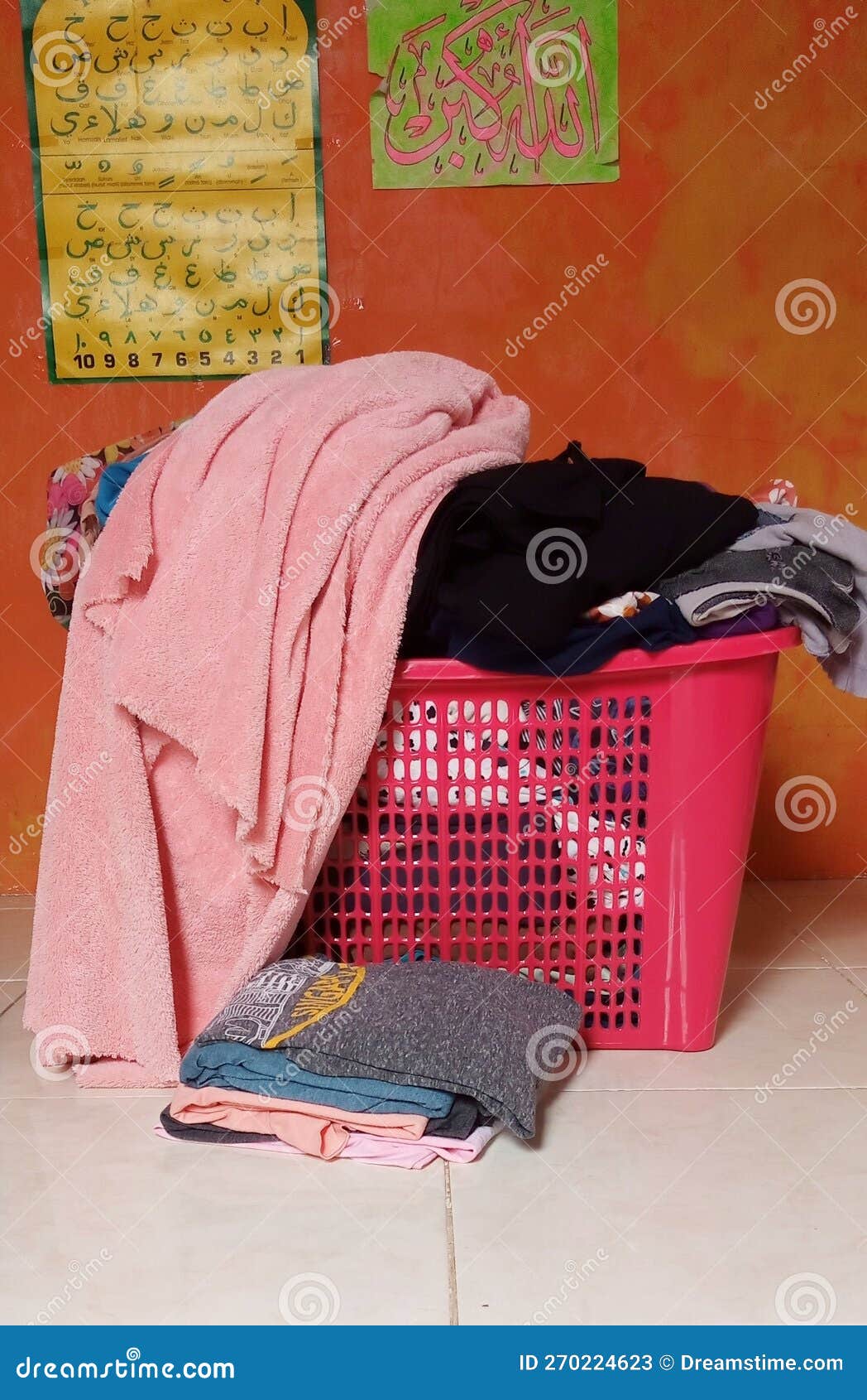 A Red Laundry Basket with Piles of Clothes Stock Image - Image of ...