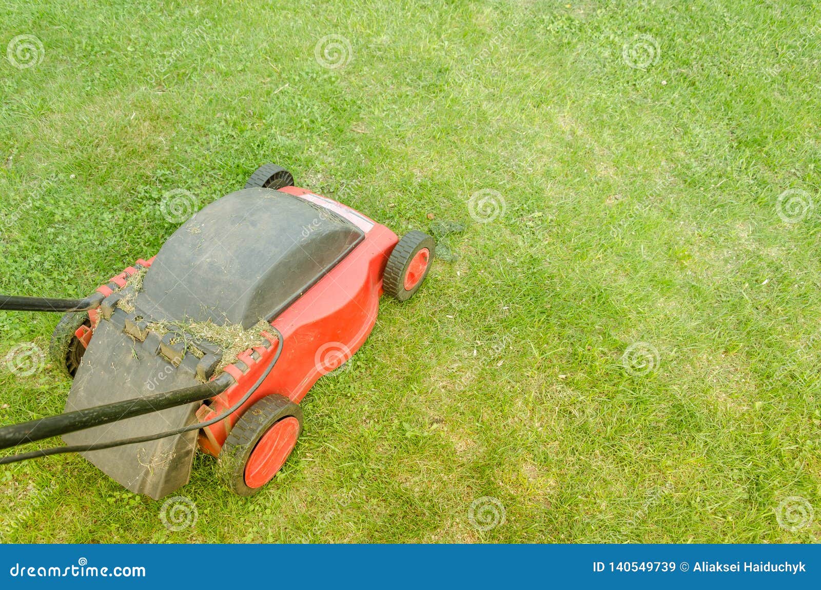 Red Lawn Mower on the Lawn/red Lawn Mower on the Lawn. Top View Stock ...