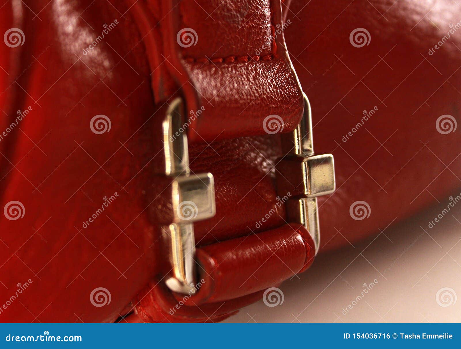 Red Leather Handbag with Red Stitching and Silver Buckle Feature Stock ...