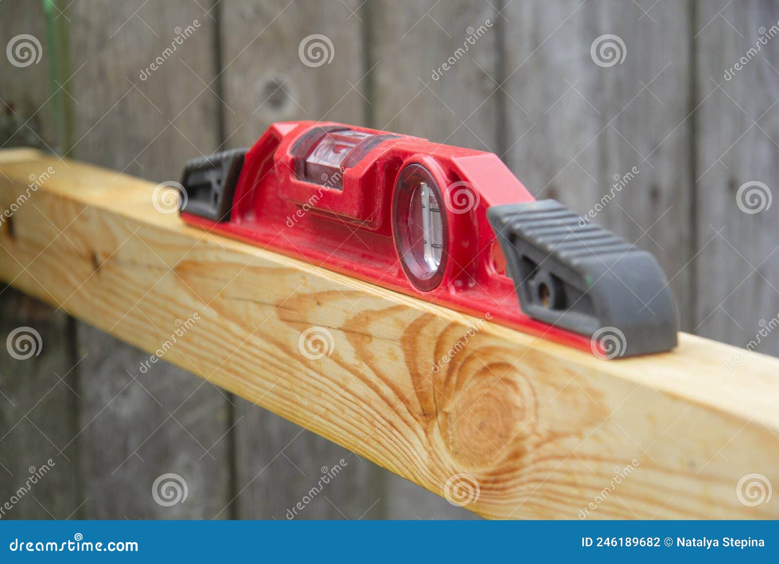 Red Level Tool Standing on the Board Sideways Stock Photo - Image of ...