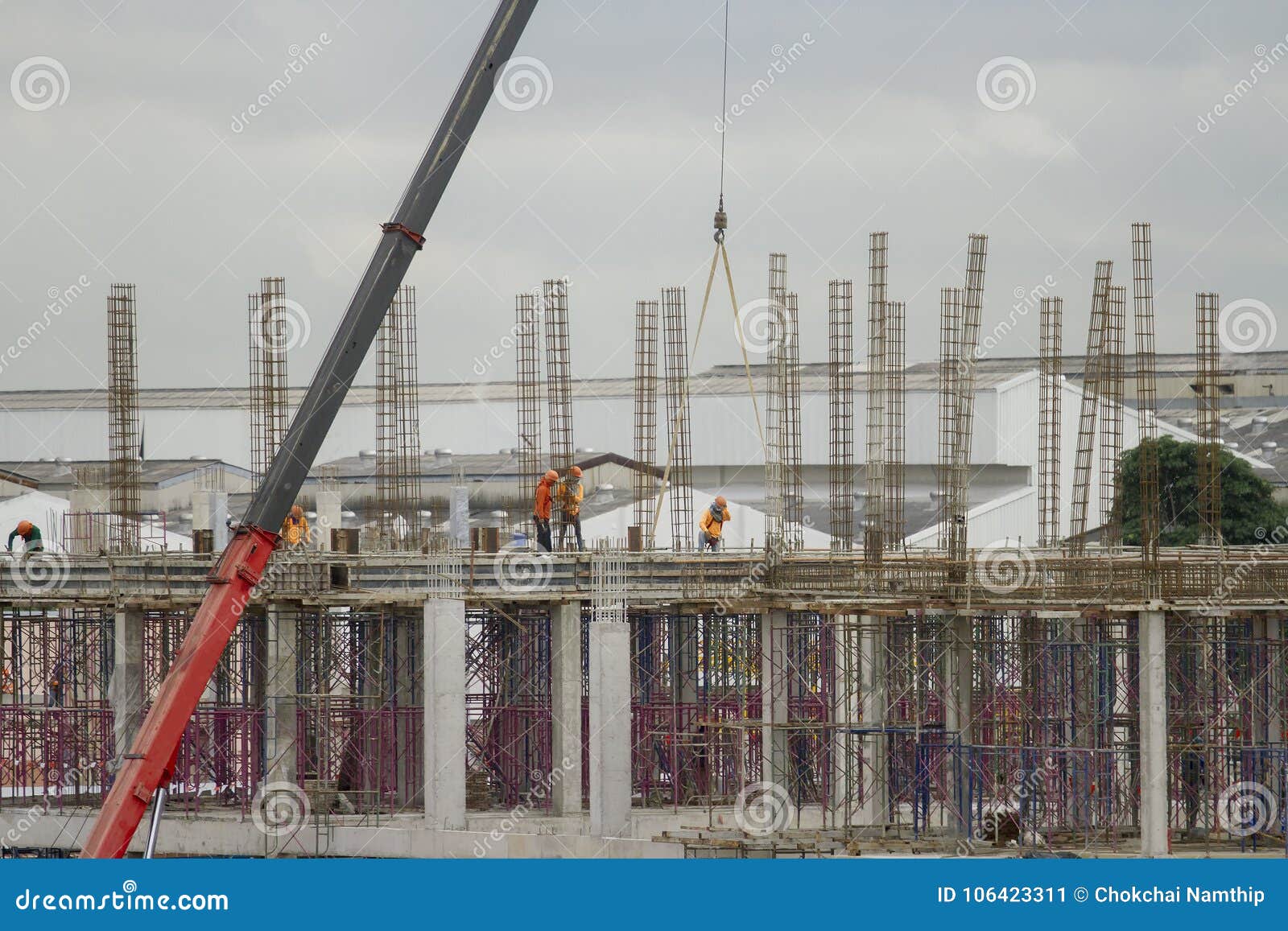 Red Lift Cranes with Workers Under Construction. Stock Image - Image of ...
