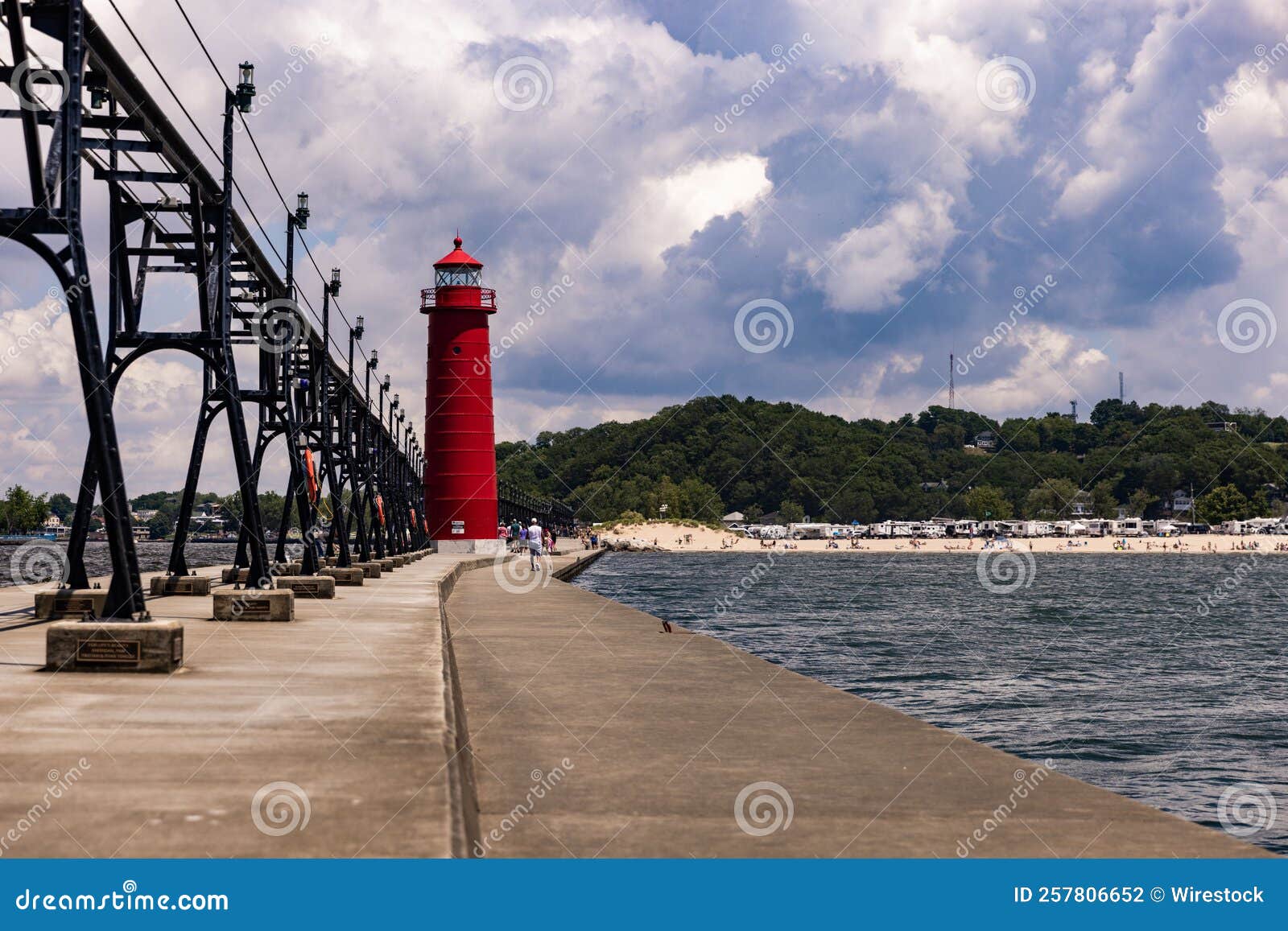 Red Lighthouse by the Beach with a Cloudy Blue Sky Background Stock ...
