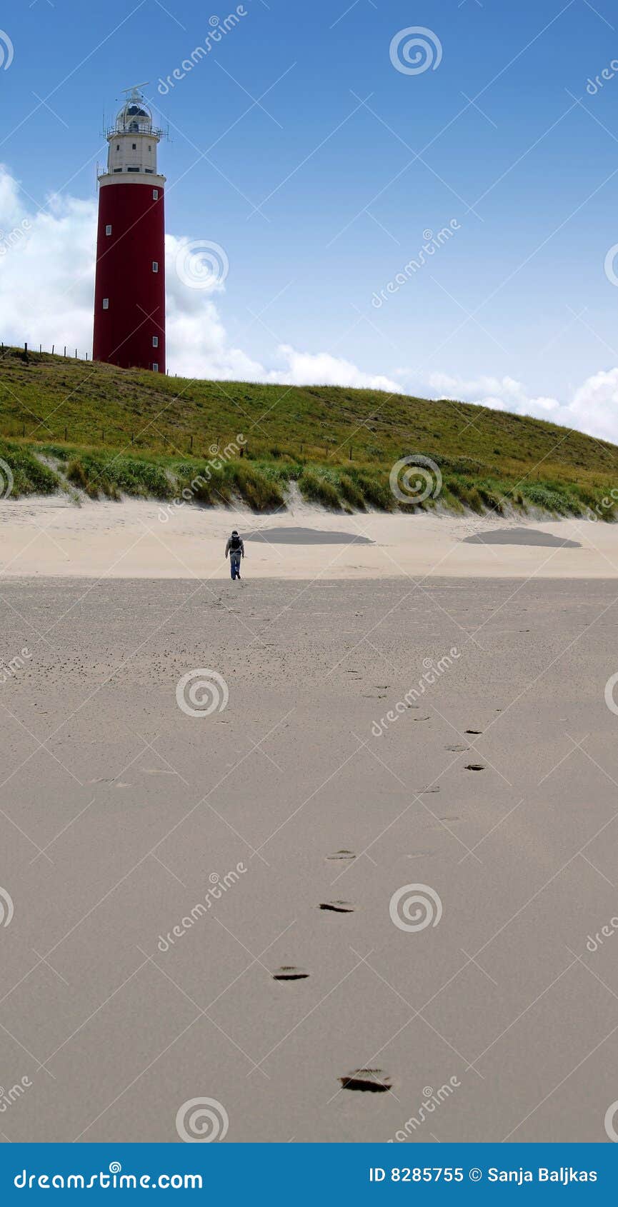 Red Lighthouse with Footsteps on the Beach Stock Image - Image of ...