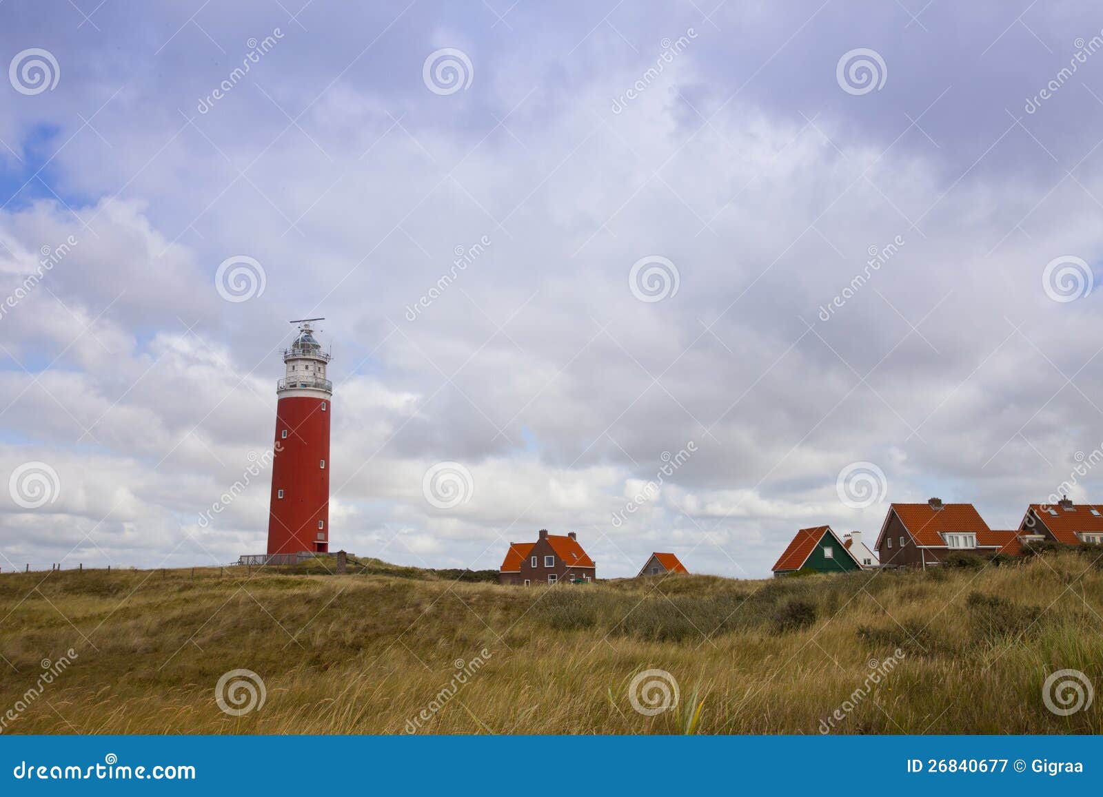 Red lighthouse and houses stock image. Image of netherlands - 26840677