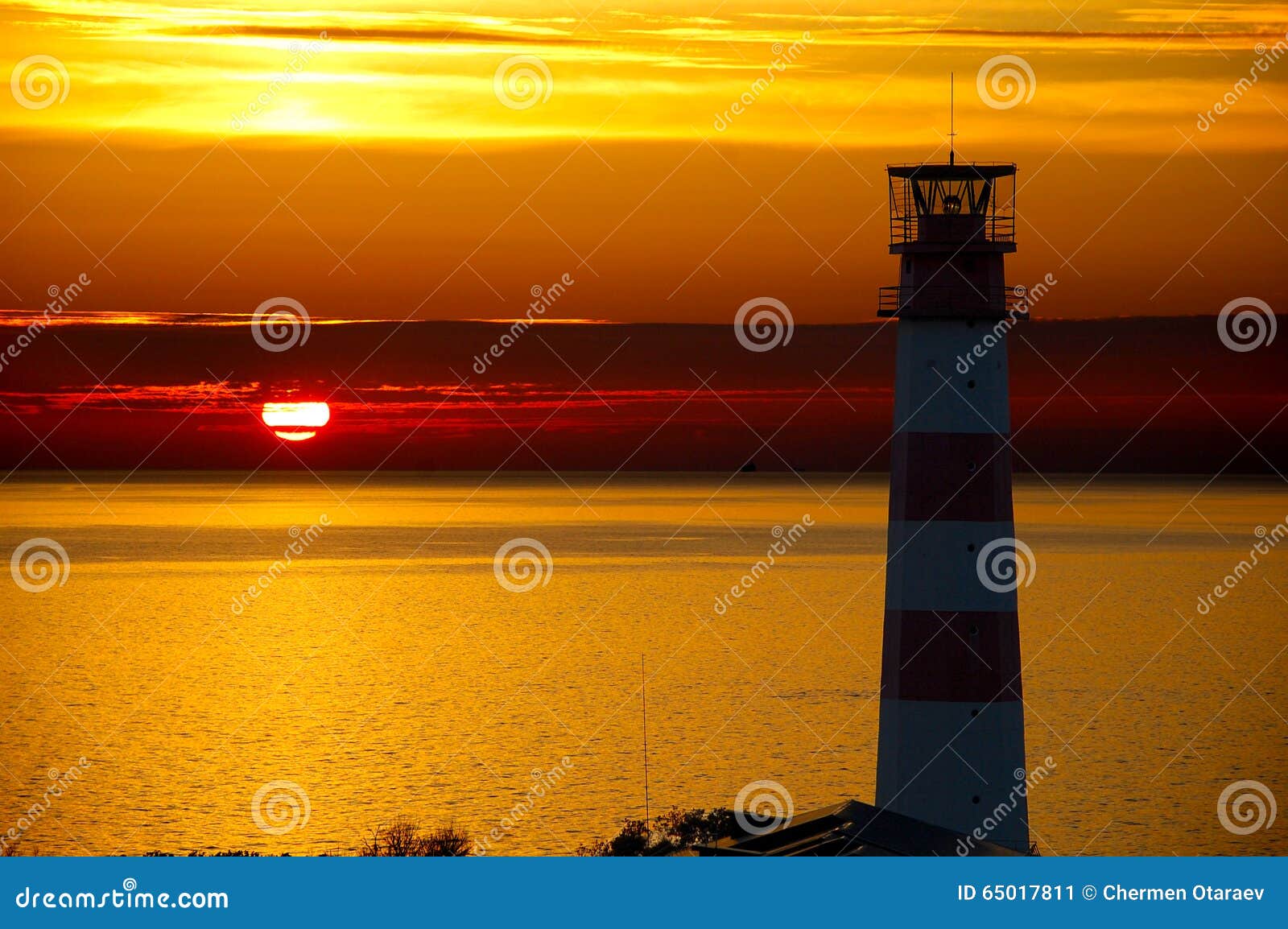 Red Lighthouse with Light Beam at Sunset. the Top Stock Image - Image ...
