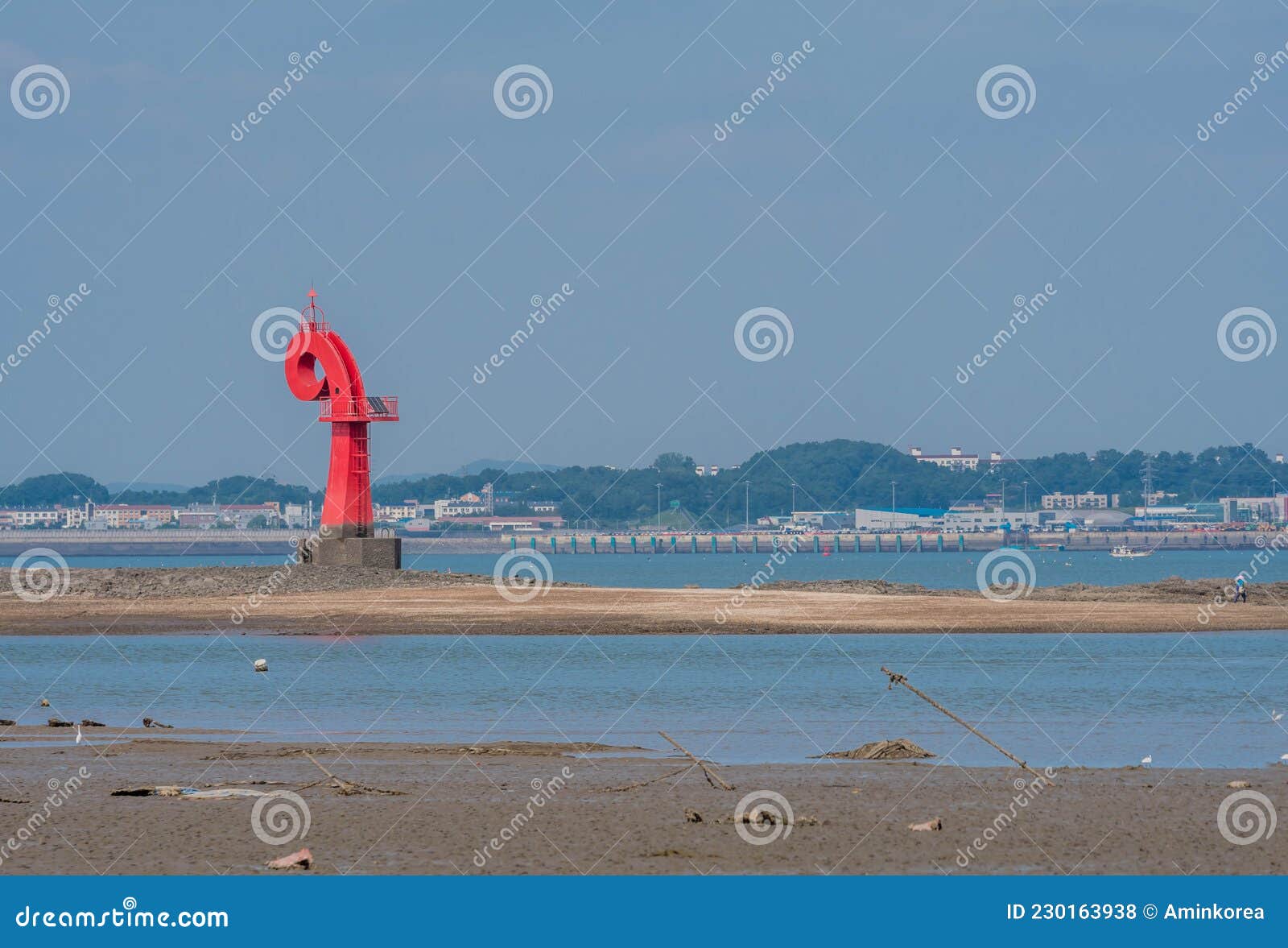Red Lighthouse on Sandbar in Harbor Stock Photo - Image of buildings ...