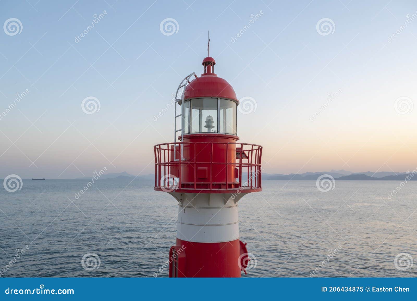 Red lighthouse by the sea stock image. Image of island - 206434875