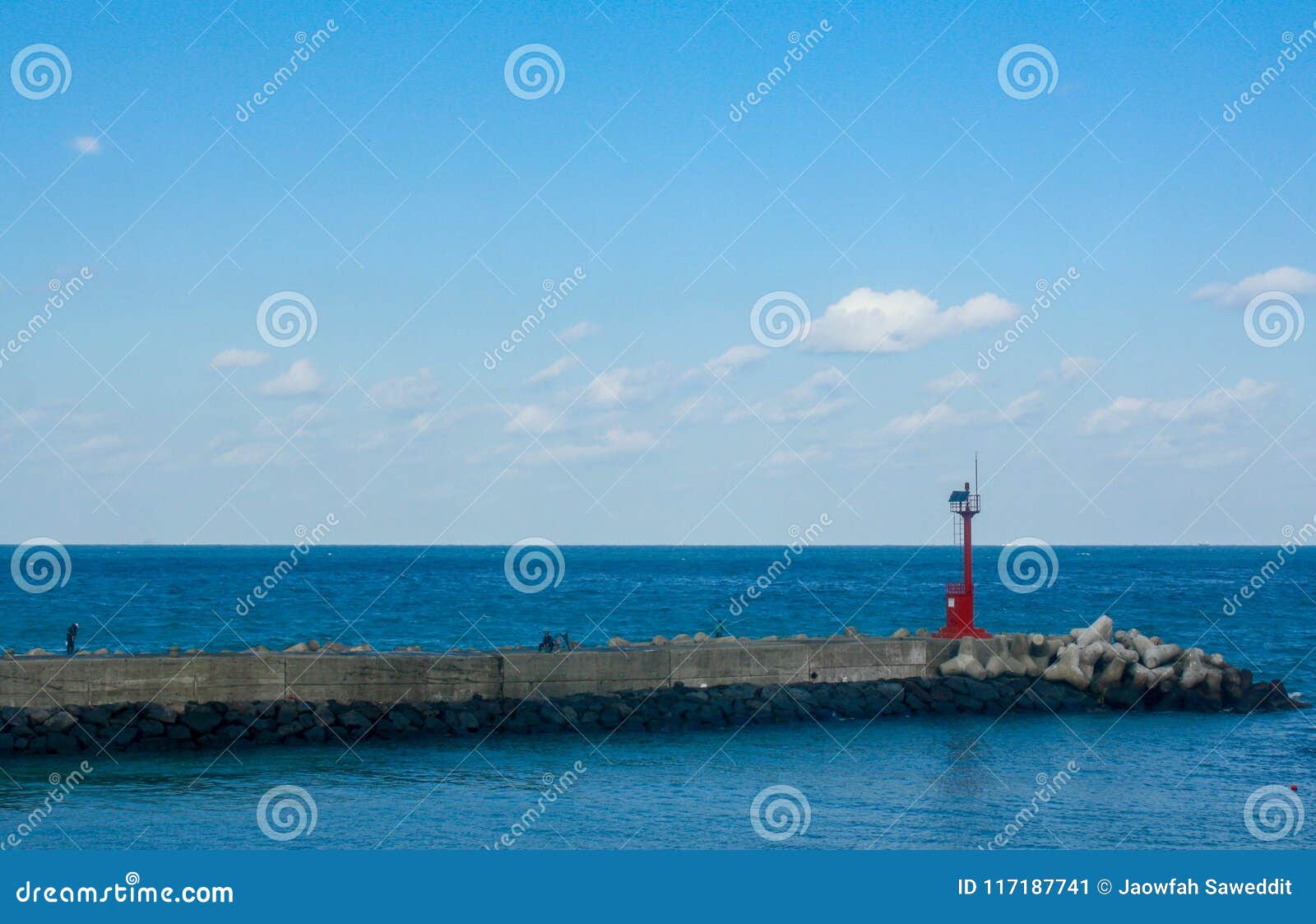 Red lighthouse by the sea stock image. Image of clouds - 117187741