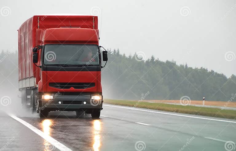 Red lorry on wet road stock photo. Image of motor, interstate - 11036328
