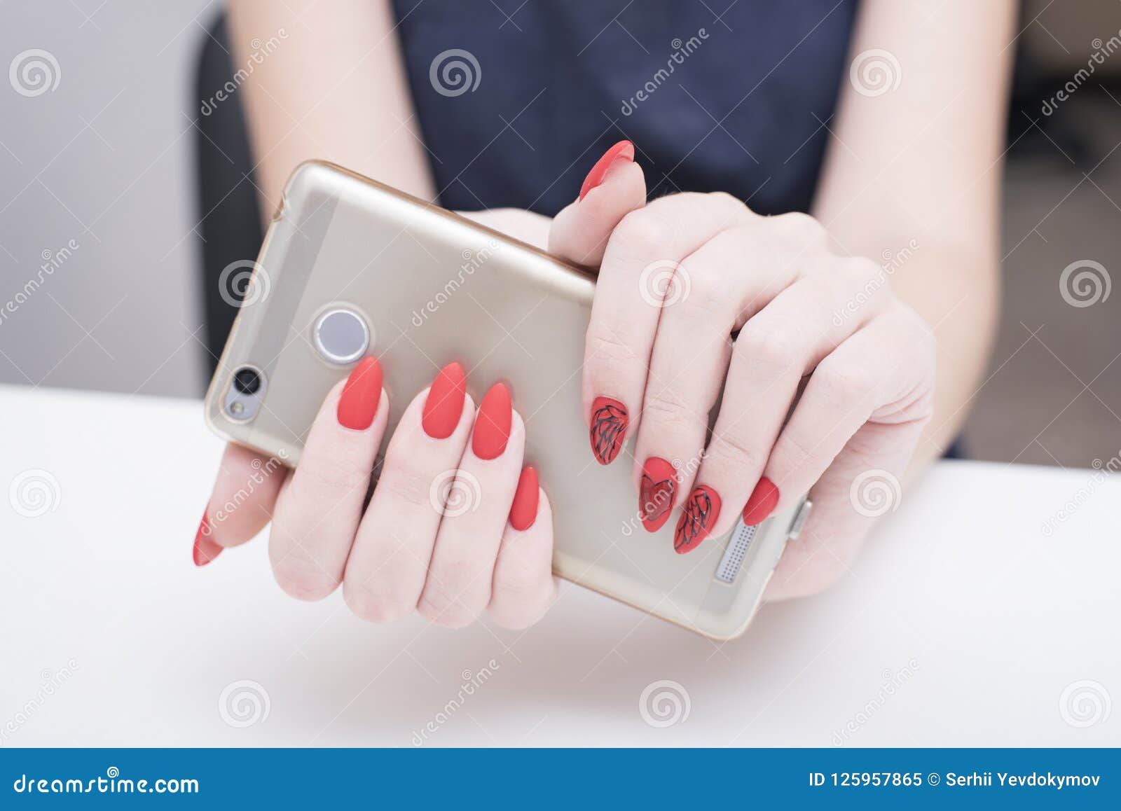 Red Manicure with a Pattern. Smart Phone in Female Hand. Stock Image ...