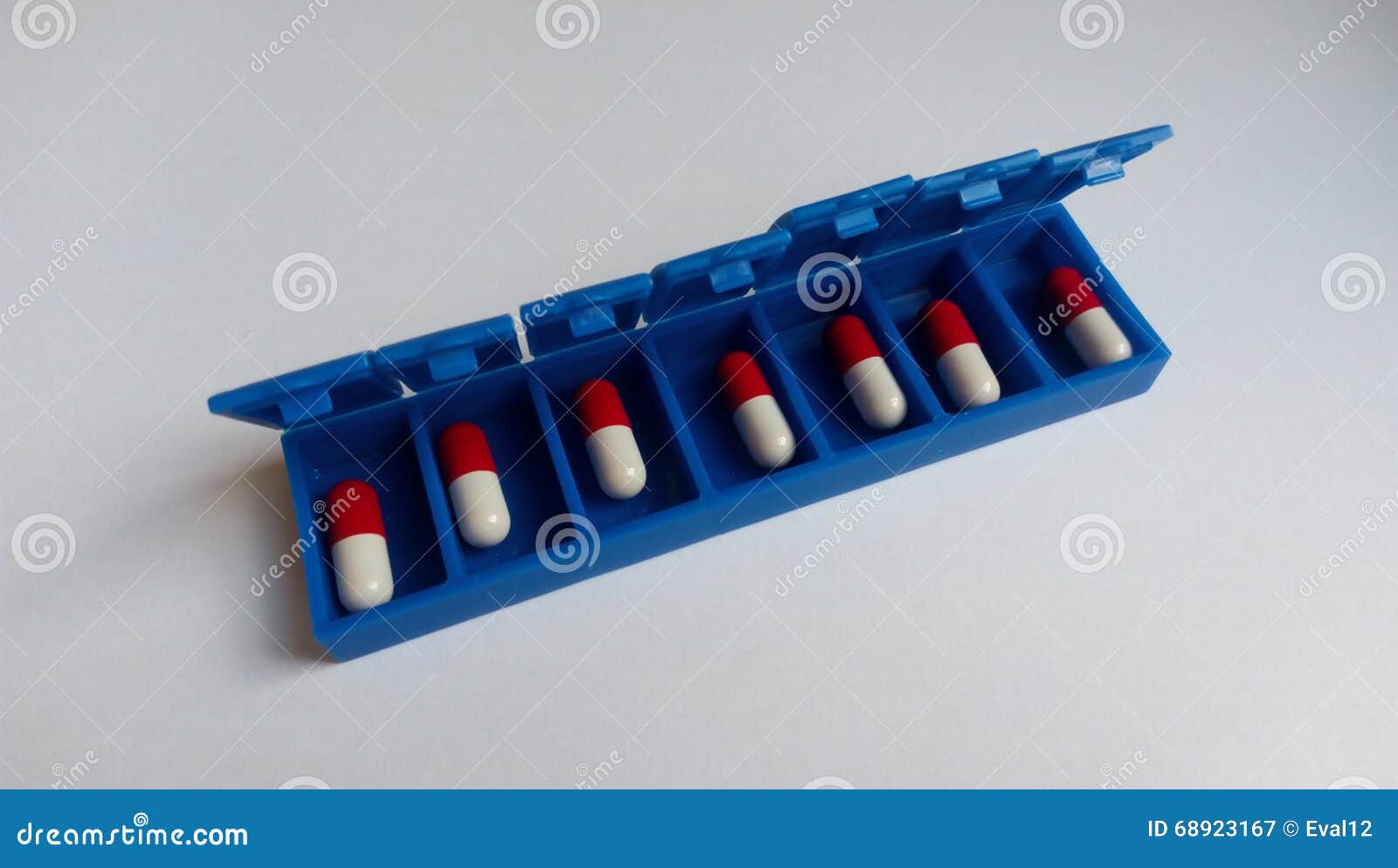 Red Medication Capsules in Dosage Blue Box on a White Background Stock ...