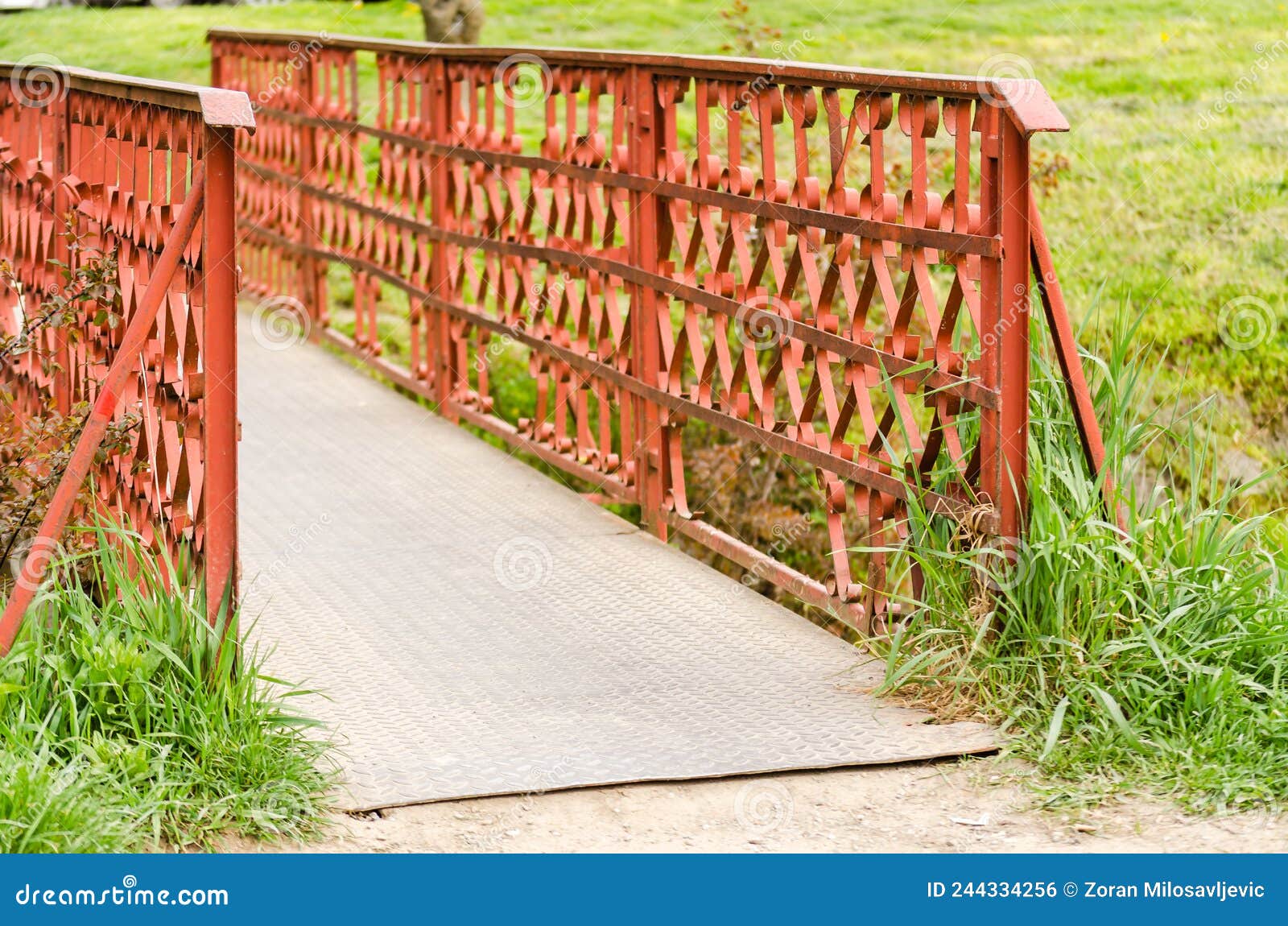 Red Metal Bridge Over the Canal Stock Photo - Image of grass, brick ...