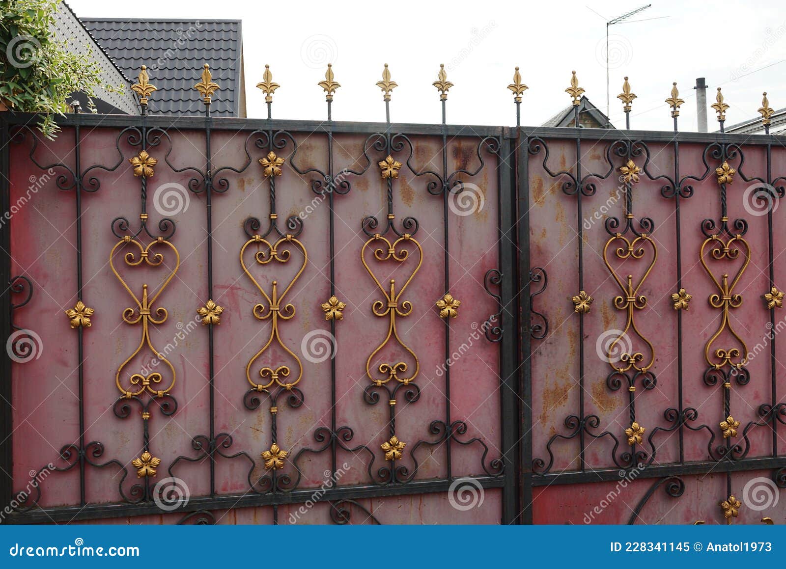 Red Metal Gate with a Forged Yellow Black Pattern and Sharp Rods Stock ...