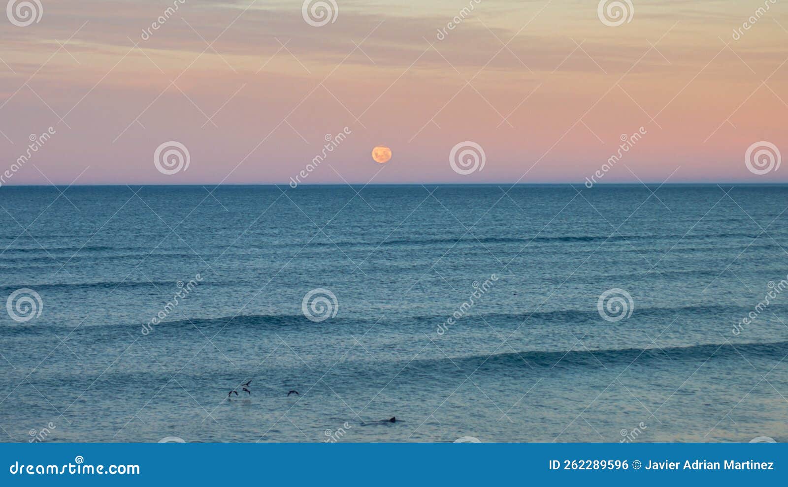 Red Moon Over the Horizon of the Sea in a Sunset. Argentina Stock Photo ...