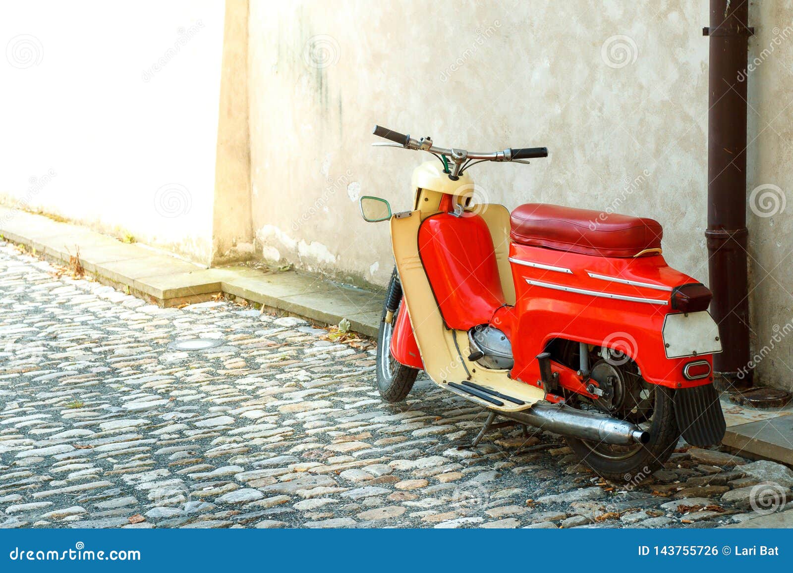 A Red Moped Stands by the Wall on the Pavement of the Old City Stock ...