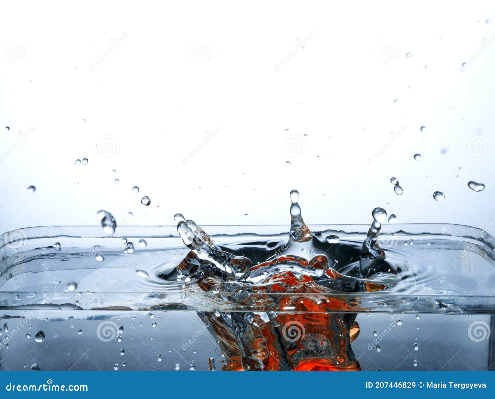 Red Object Falls on a Flat Water Surface with a Lot of Splashes ...