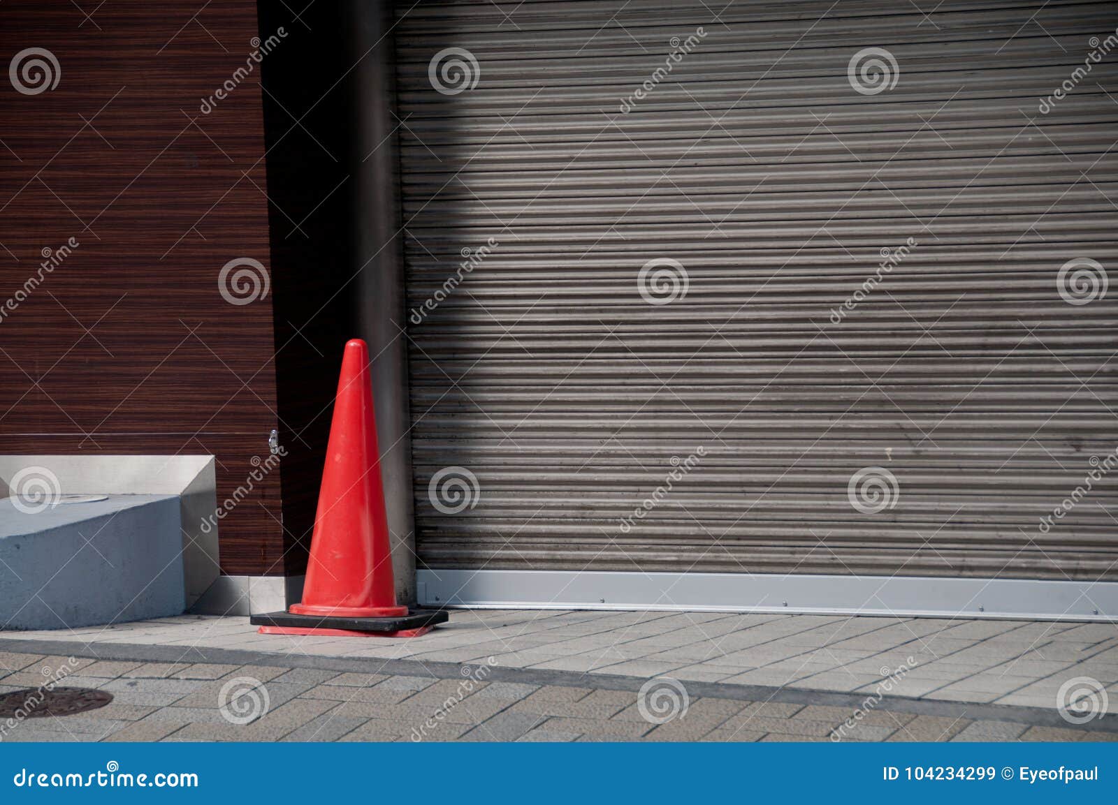 Red Plastic Cone in Front of a Shop Gate Stock Image - Image of asphalt ...
