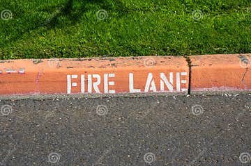 Red Painted Curb with Fire Lane Sign Stock Image - Image of building ...