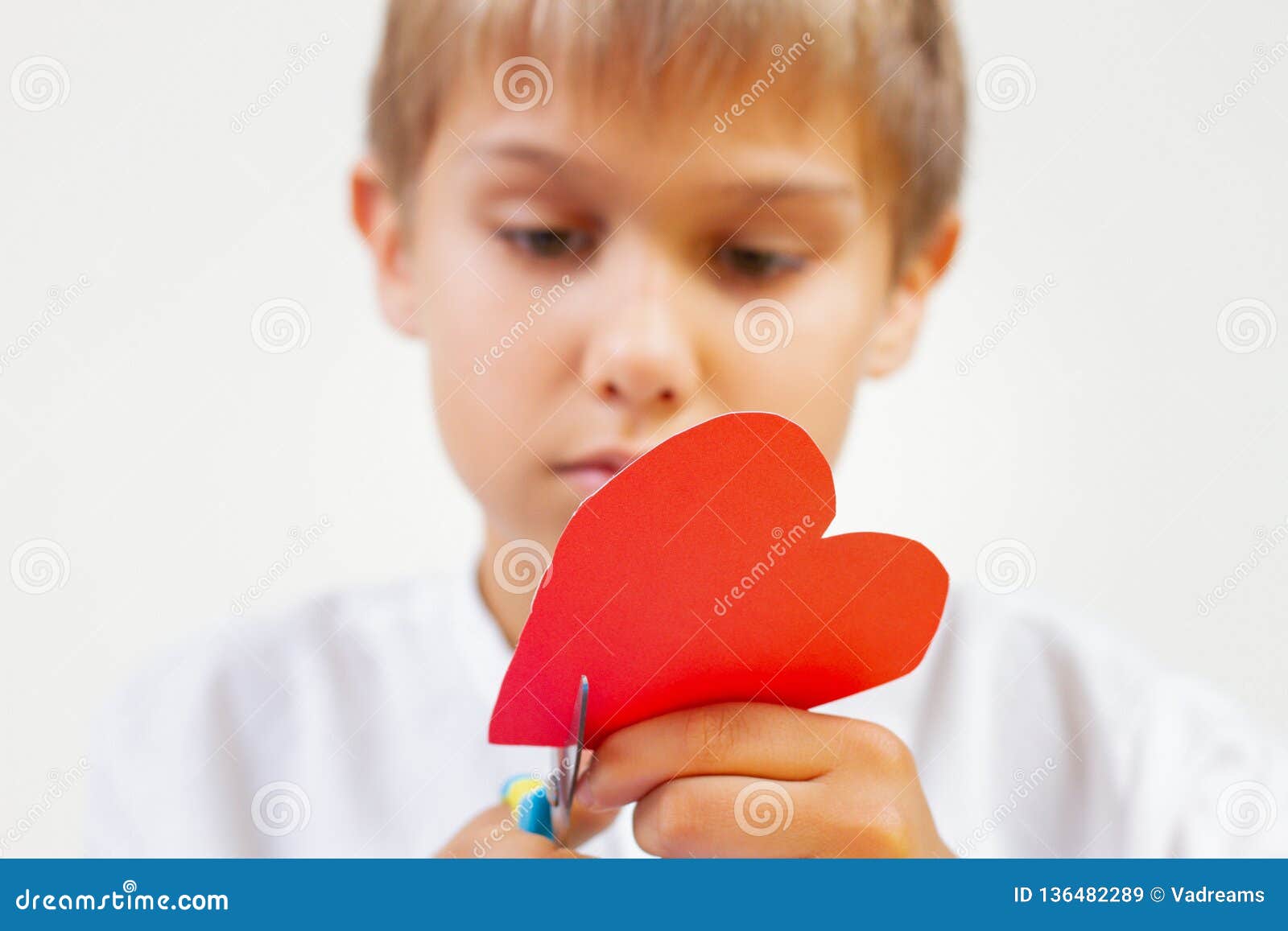 Red Paper Heart in Kid Hands. Child Cutting Red Paper Heart with ...