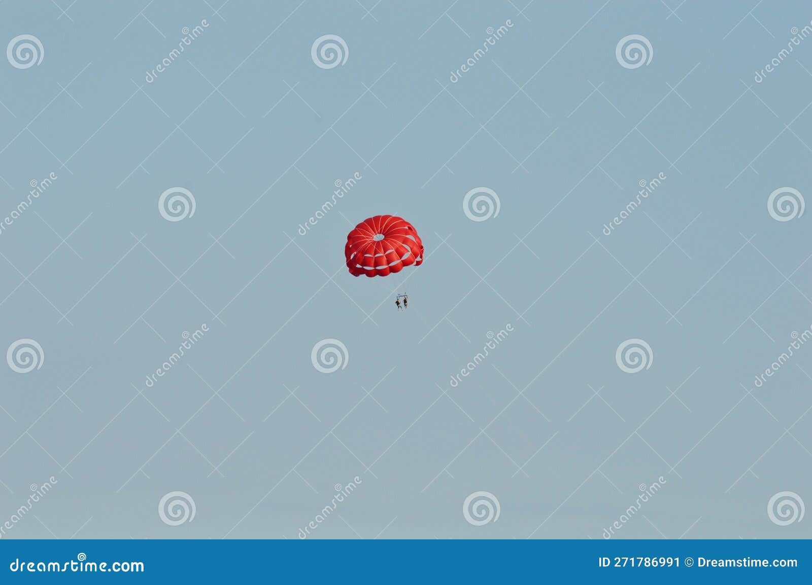 Red Parachute Carries Two People Stock Image - Image of petal, circle ...
