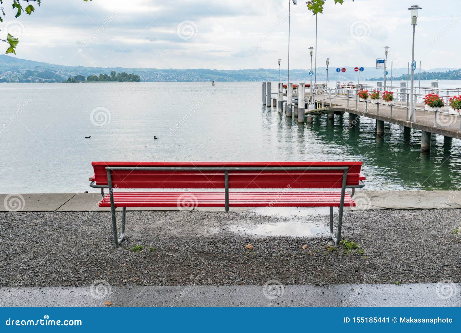 Red Park Bench on a Lake Shore with a View of the Harbor Pier Stock ...