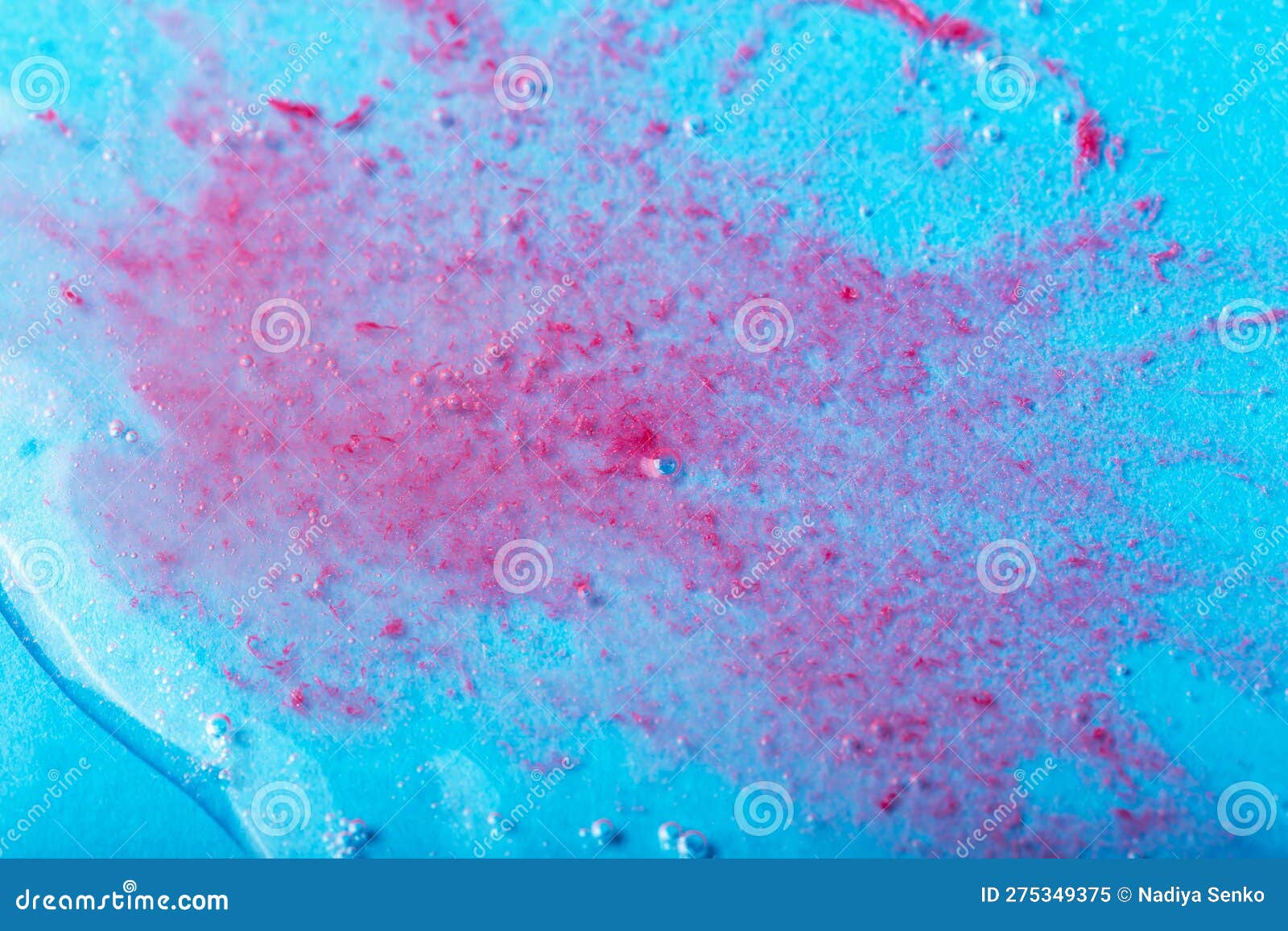 Red Particles in Transparent Liquid on Blue Background Stock Image ...