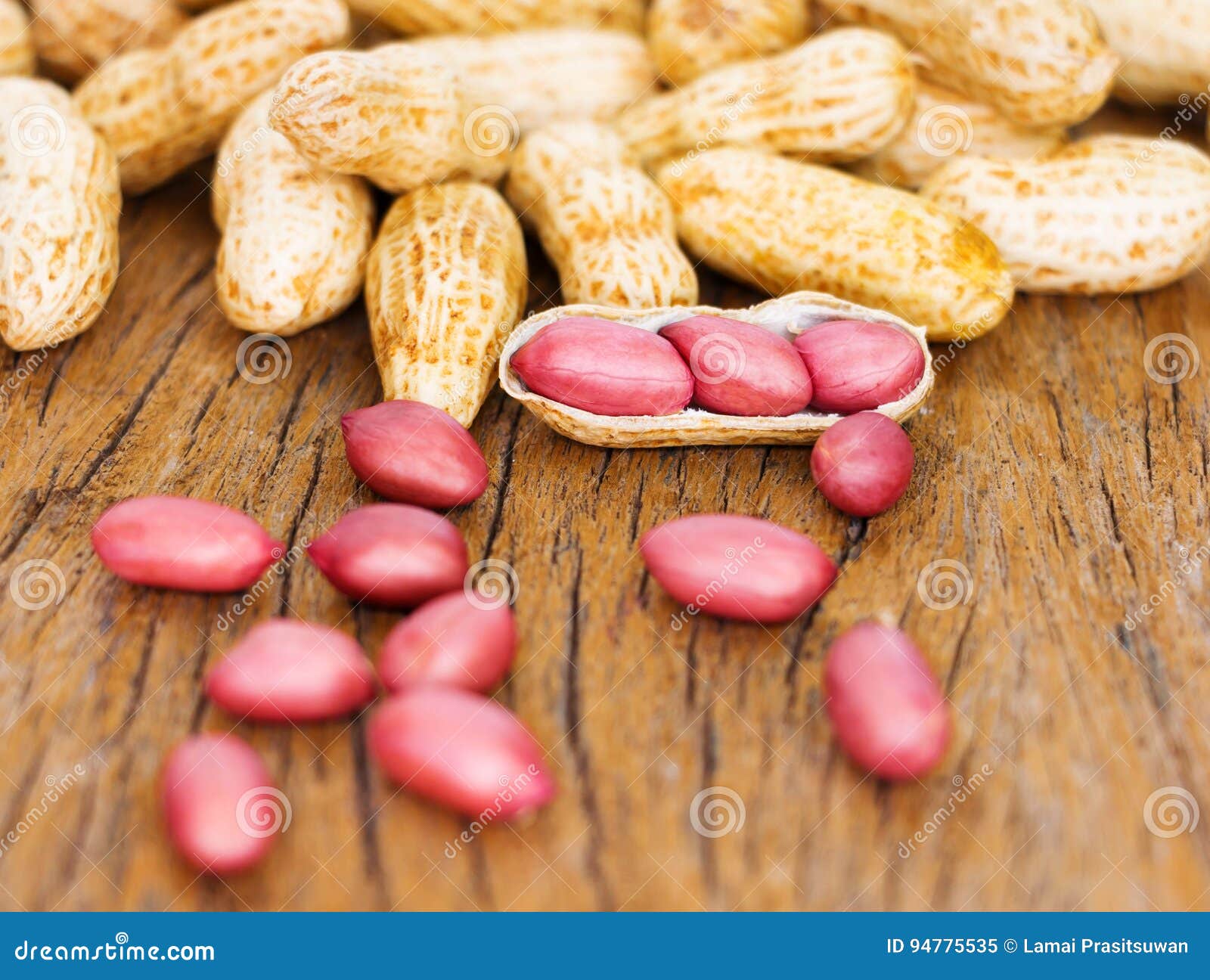 Red peanuts on wood stock image. Image of ingredient - 94775535