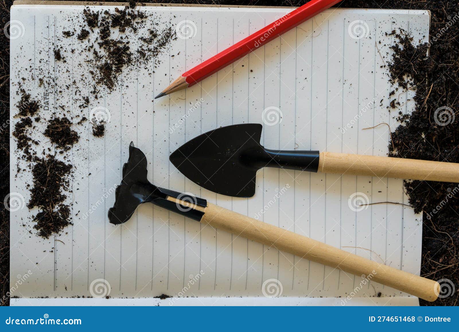 Red Pencil with Gardening Supplies and Notebook on Ground Stock Photo ...